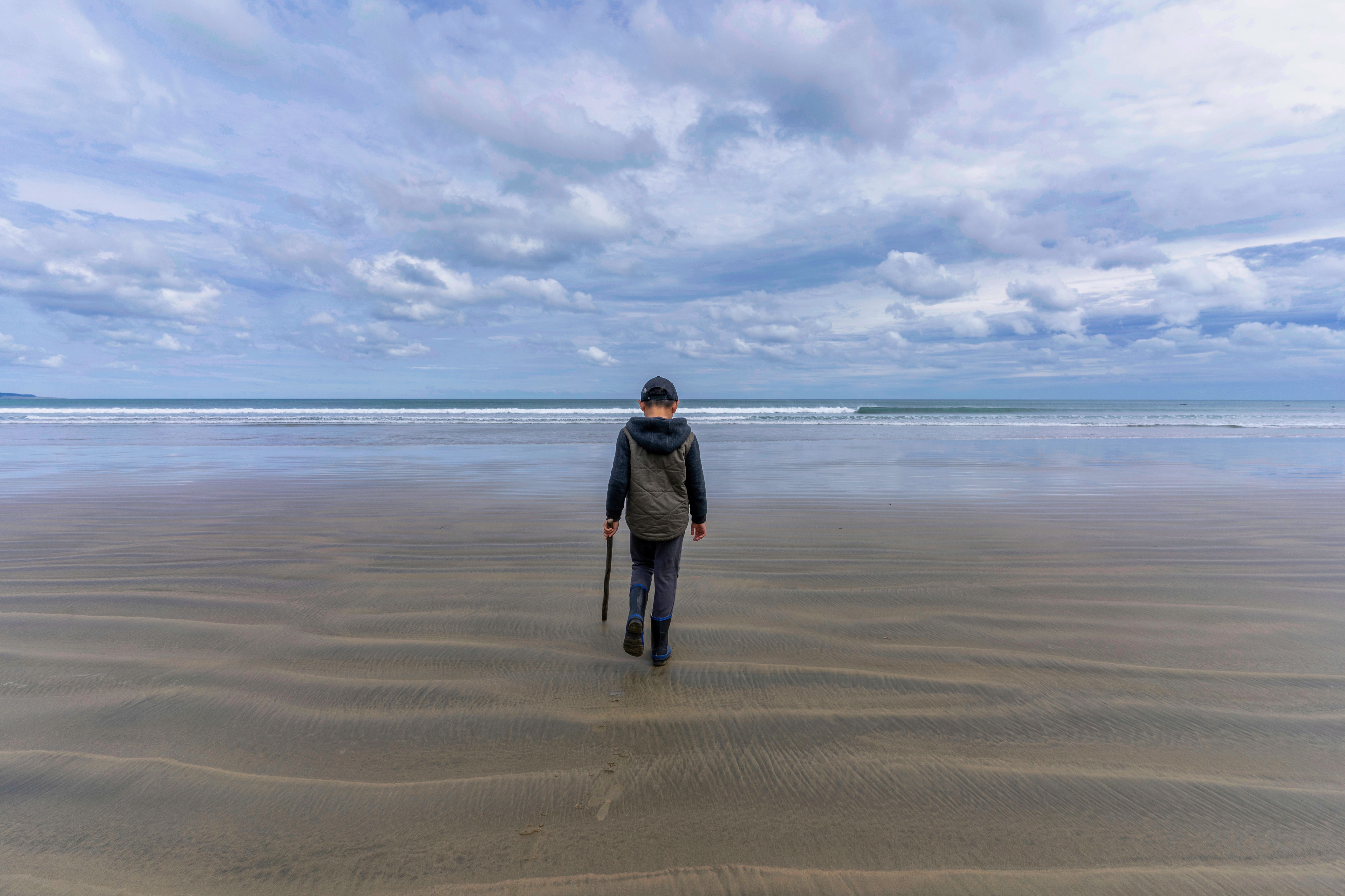 Back View of a Boy on the Beach · Free Stock Photo