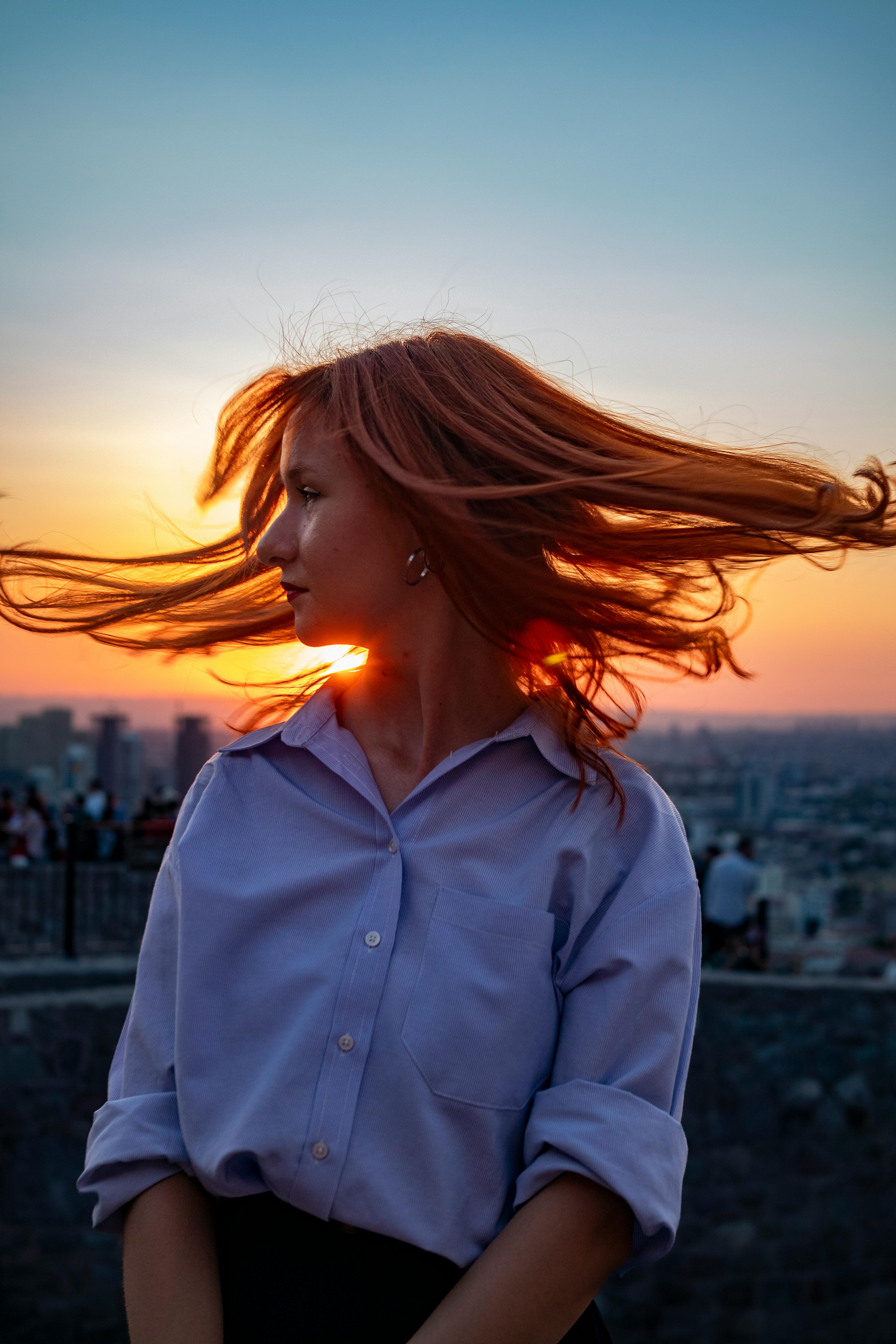 Portrait of Woman Turning Head against Sunset · Free Stock Photo