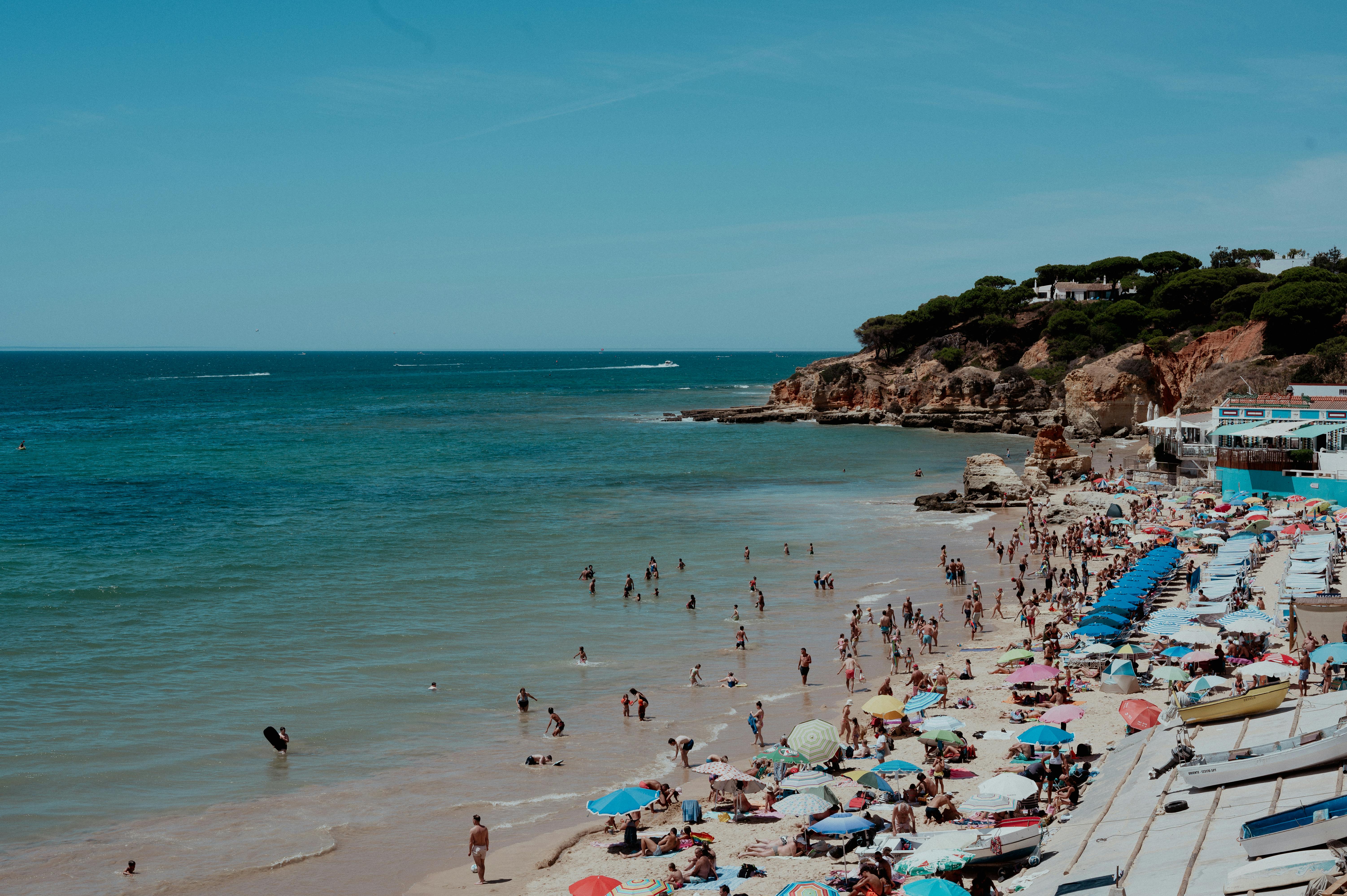 People Near Beach With Lifeguard Gazebo · Free Stock Photo