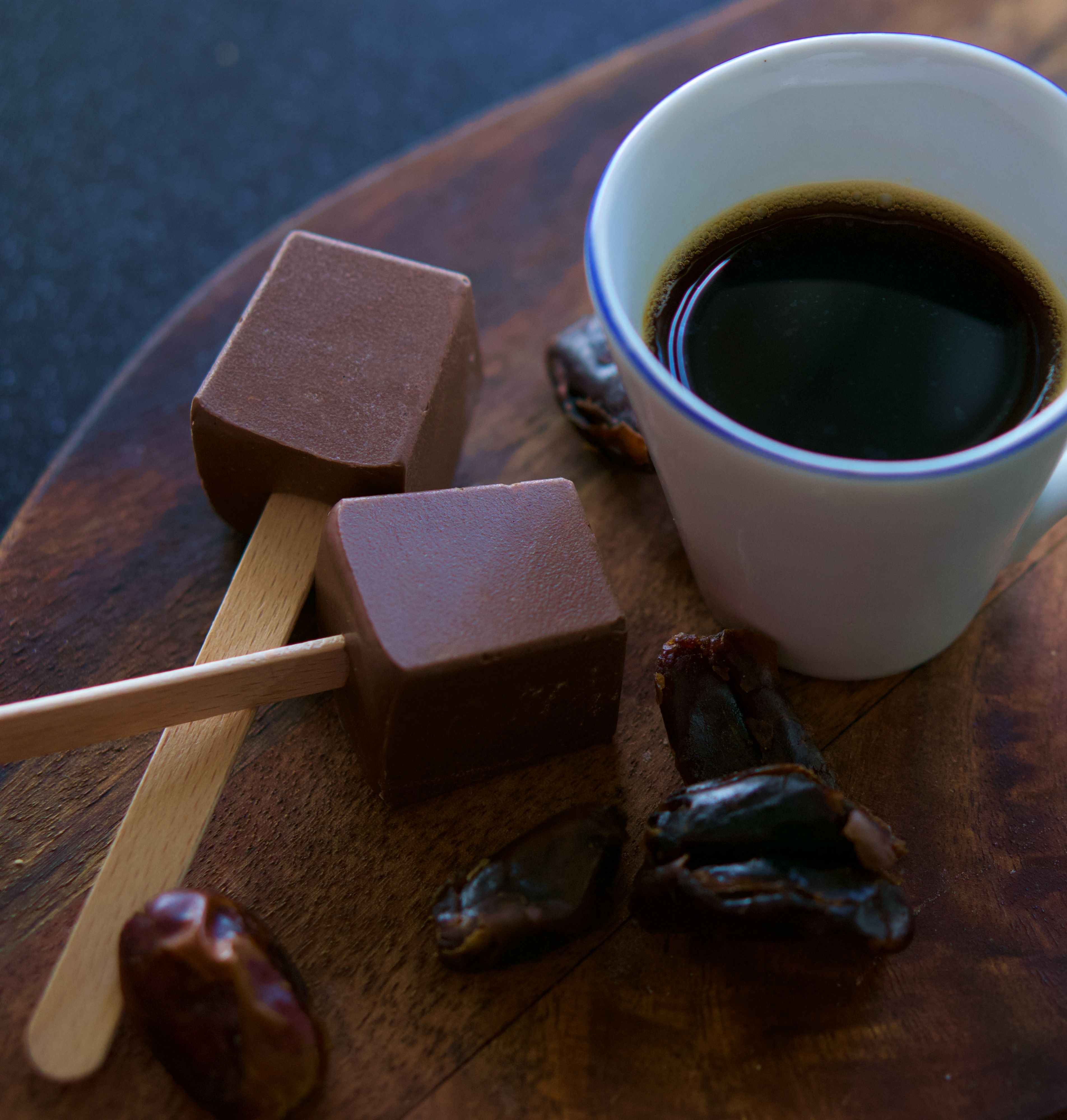Cup of Coffee, Chocolate Bars on Stick and Dates · Free Stock Photo