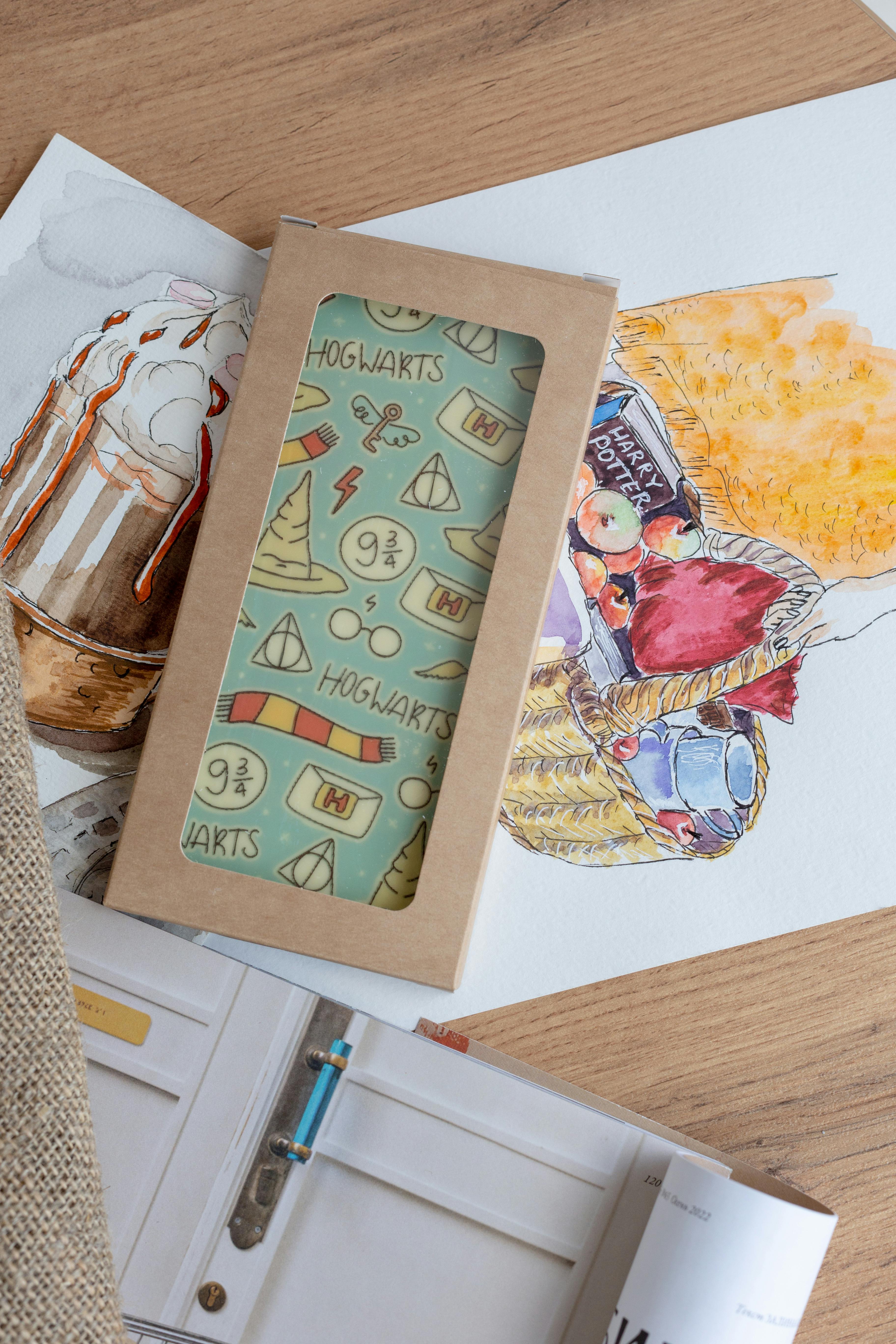 Harry Potter Book and Black Headphones With Trinket · Free Stock Photo