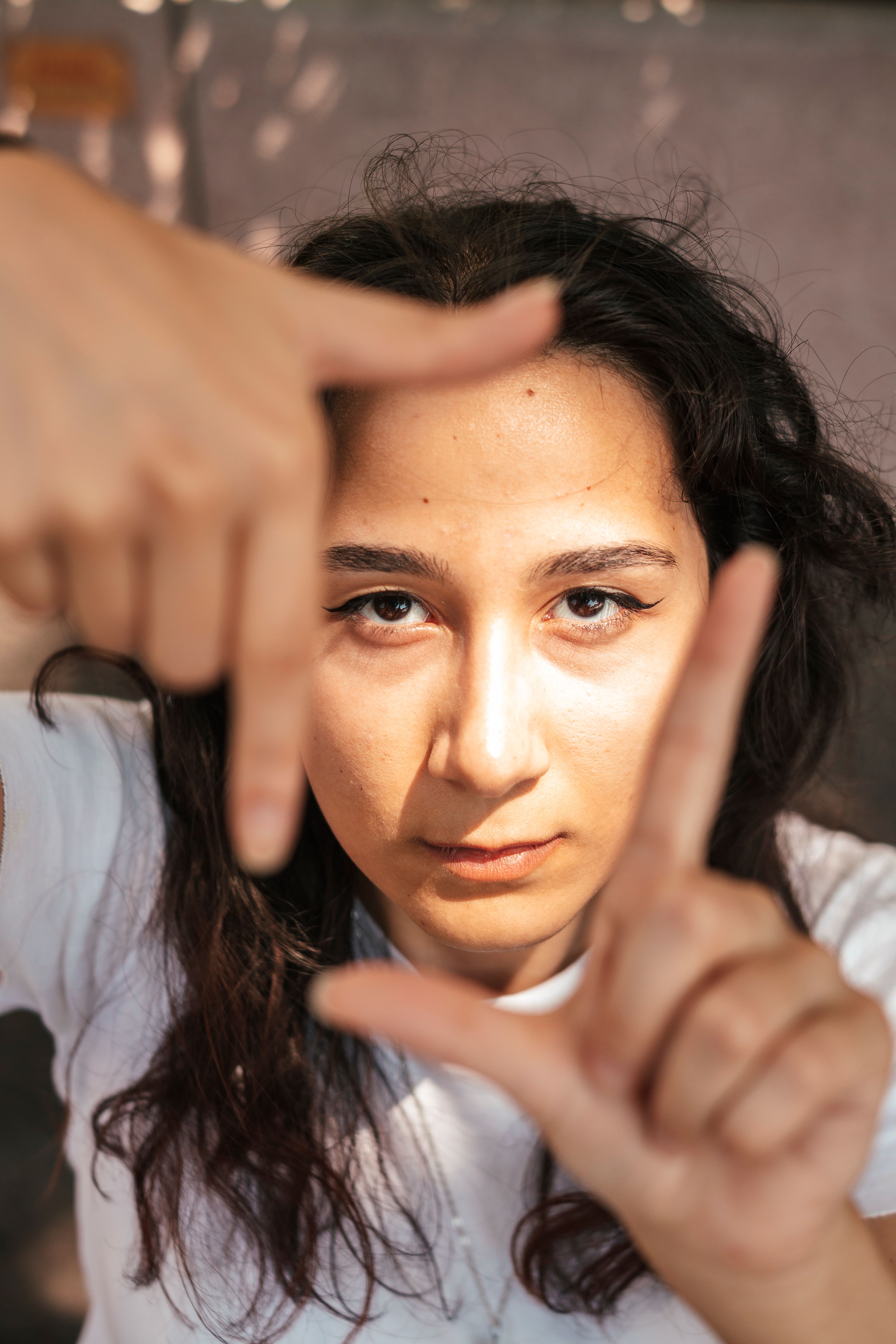 Woman Framing her Face with Sandy Hands · Free Stock Photo