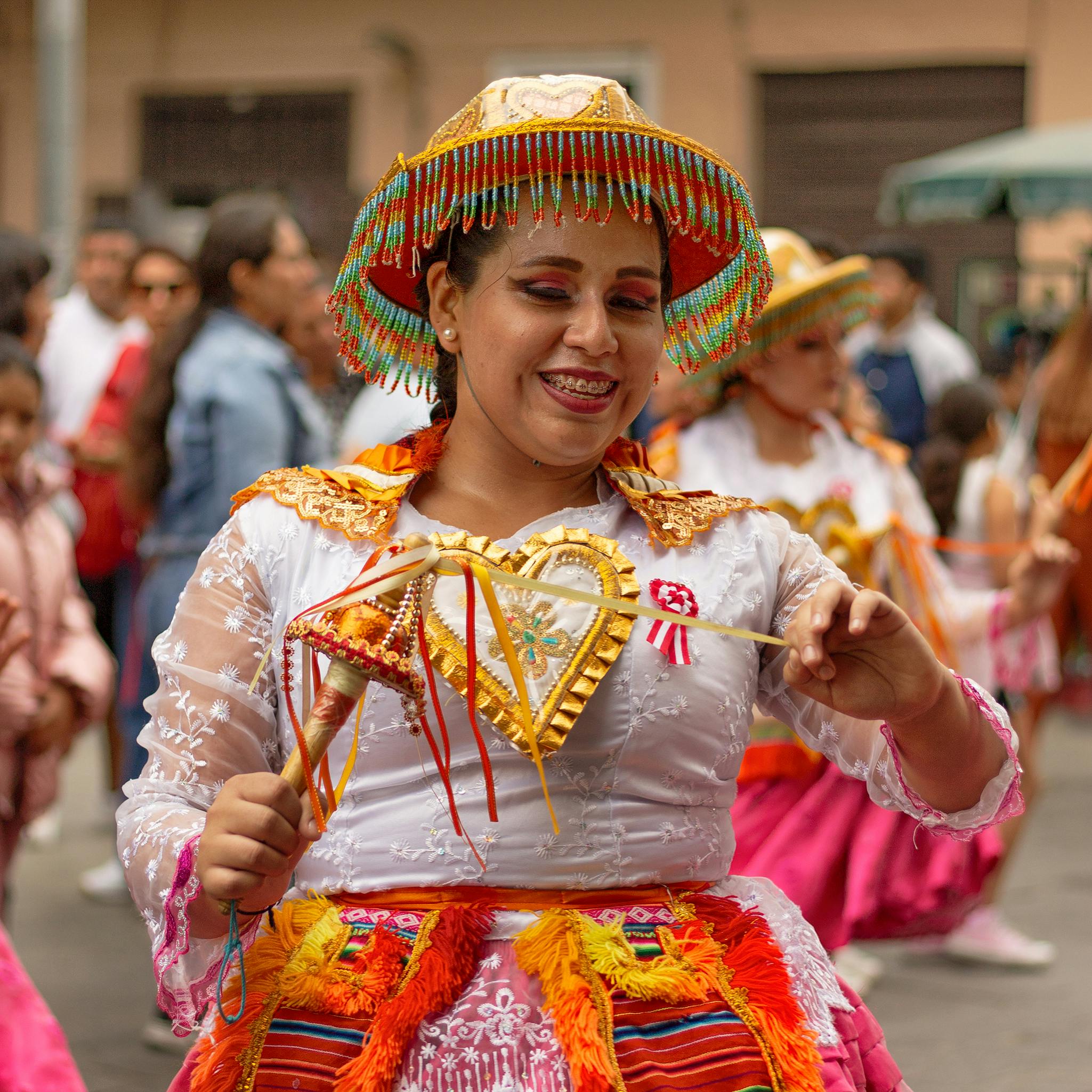 Woman in a Colorful Folk Costume Dancing during a Parade · Free Stock Photo