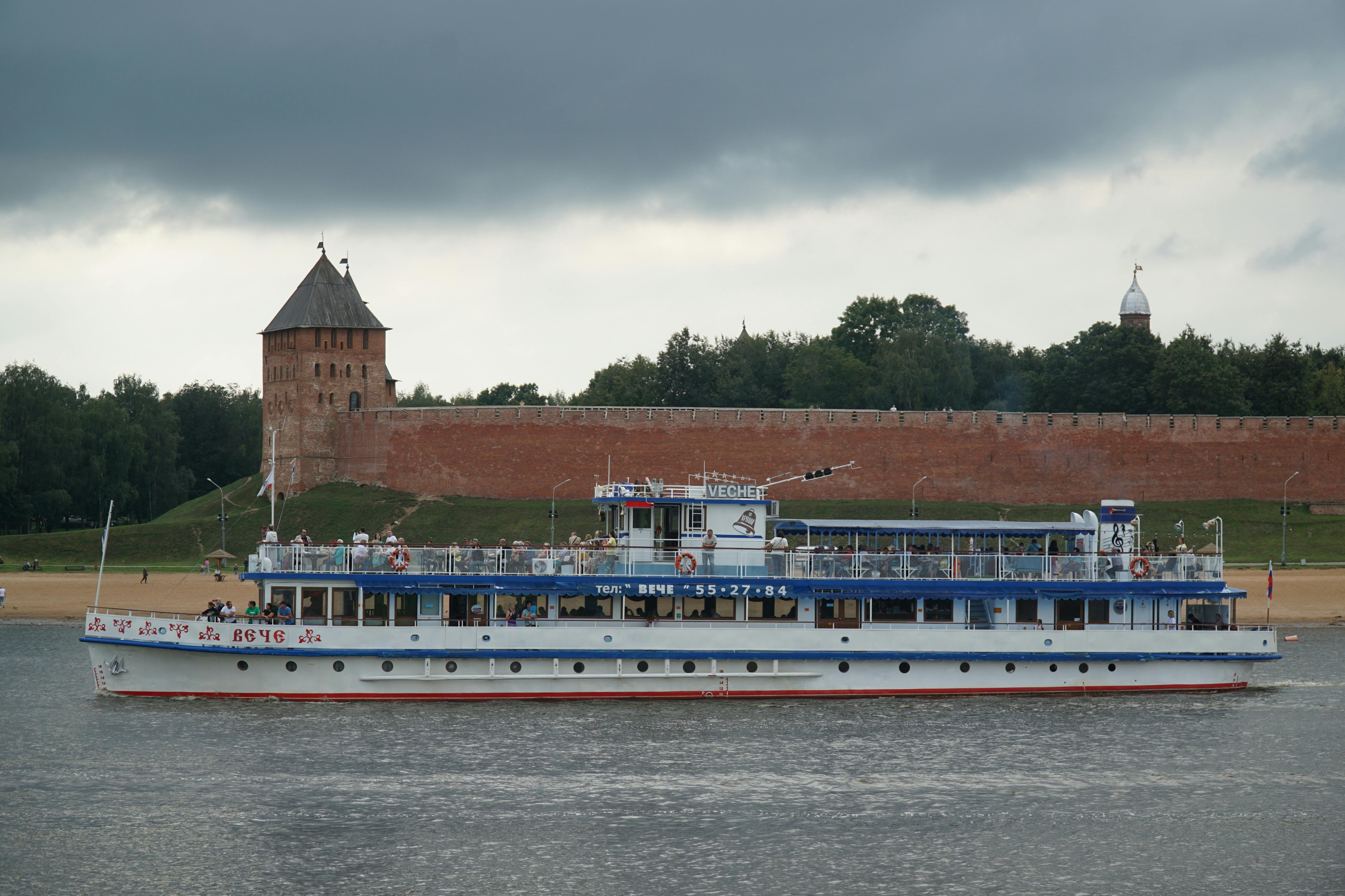 Ferries in Strait and Back View of Men Sitting on a Bench · Free Stock ...