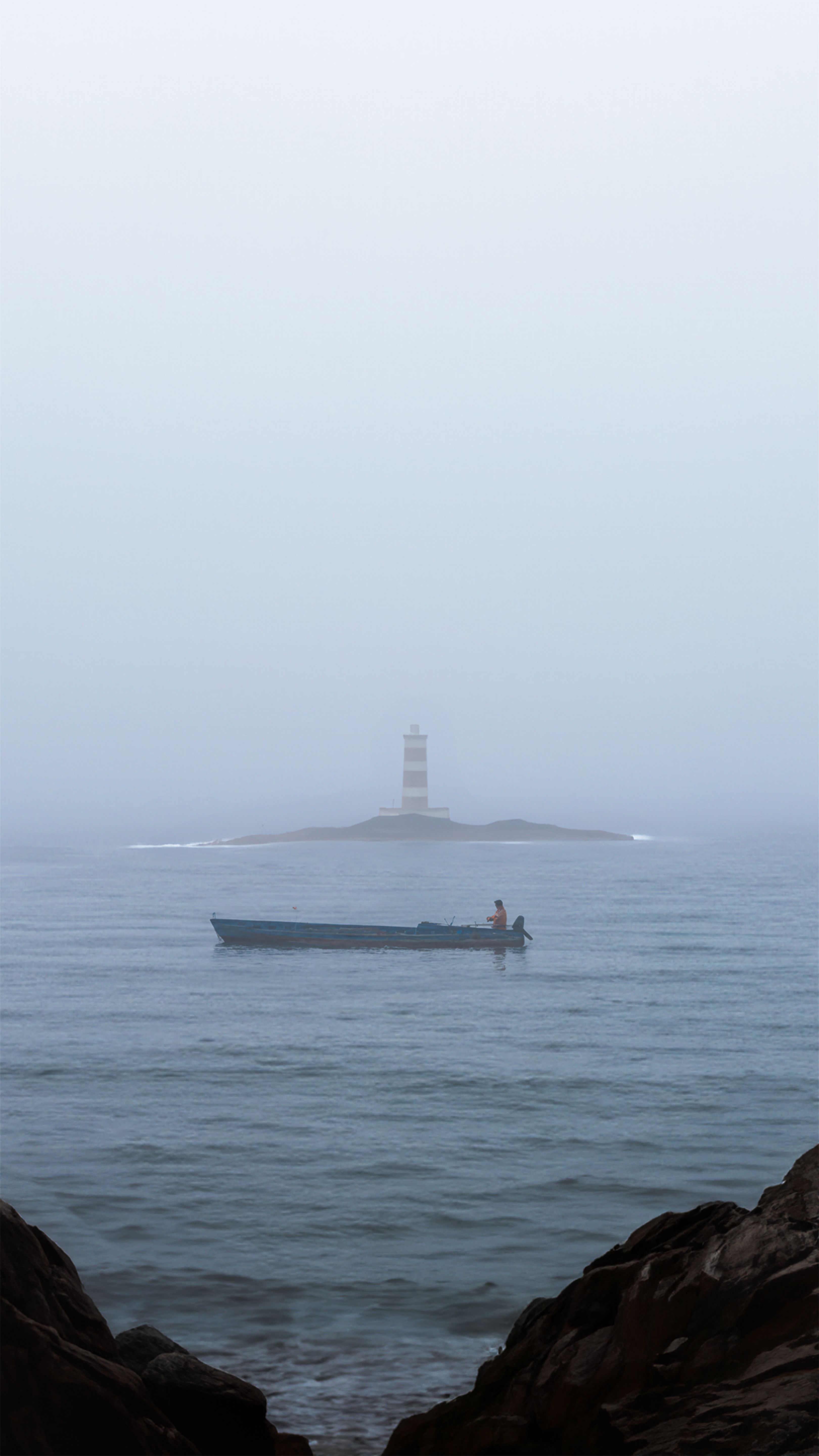 Fishing Motorboat Sailing by Islet with Lighthouse · Free Stock Photo
