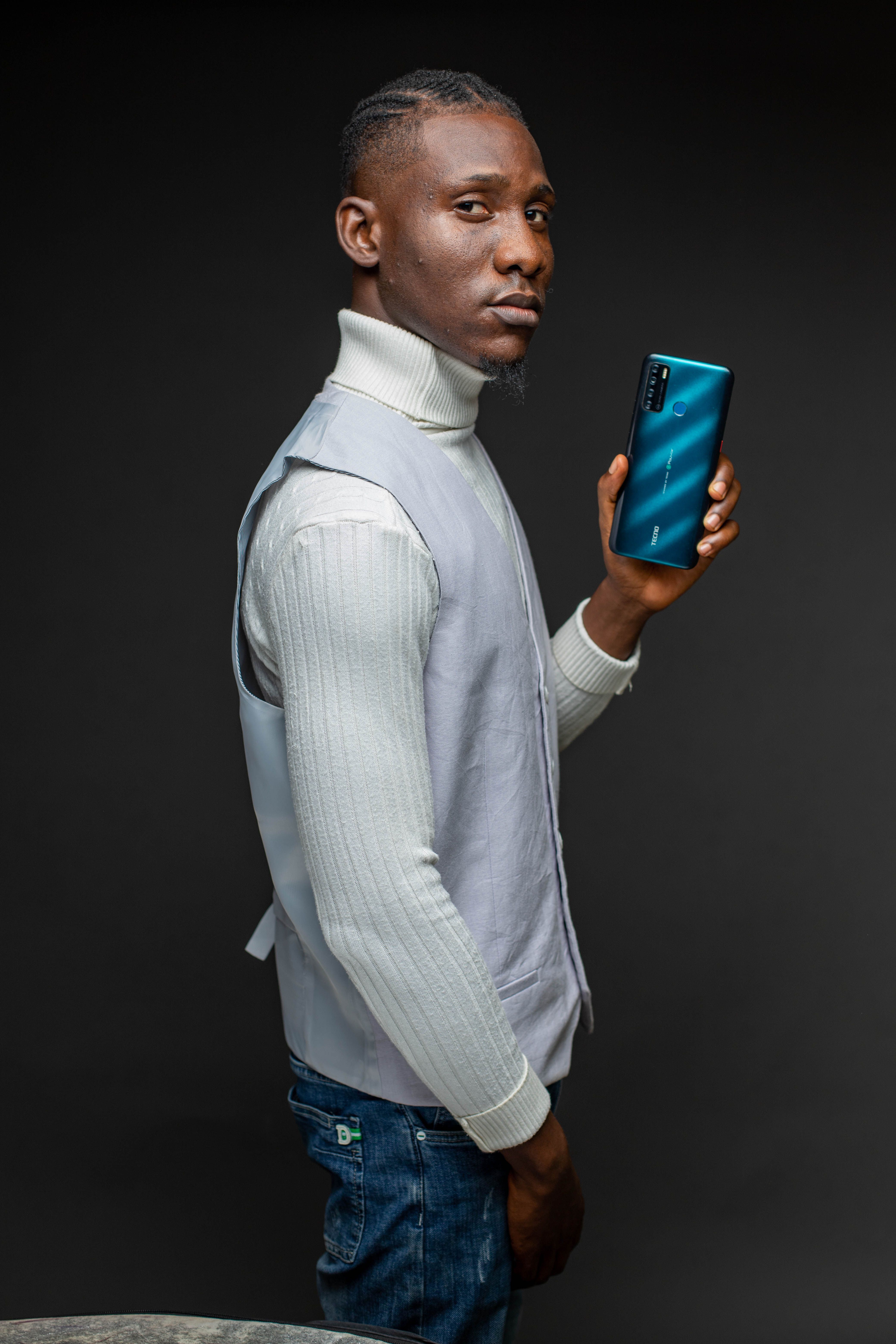 Man in White Turtleneck Presenting Blue Smartphone · Free Stock Photo