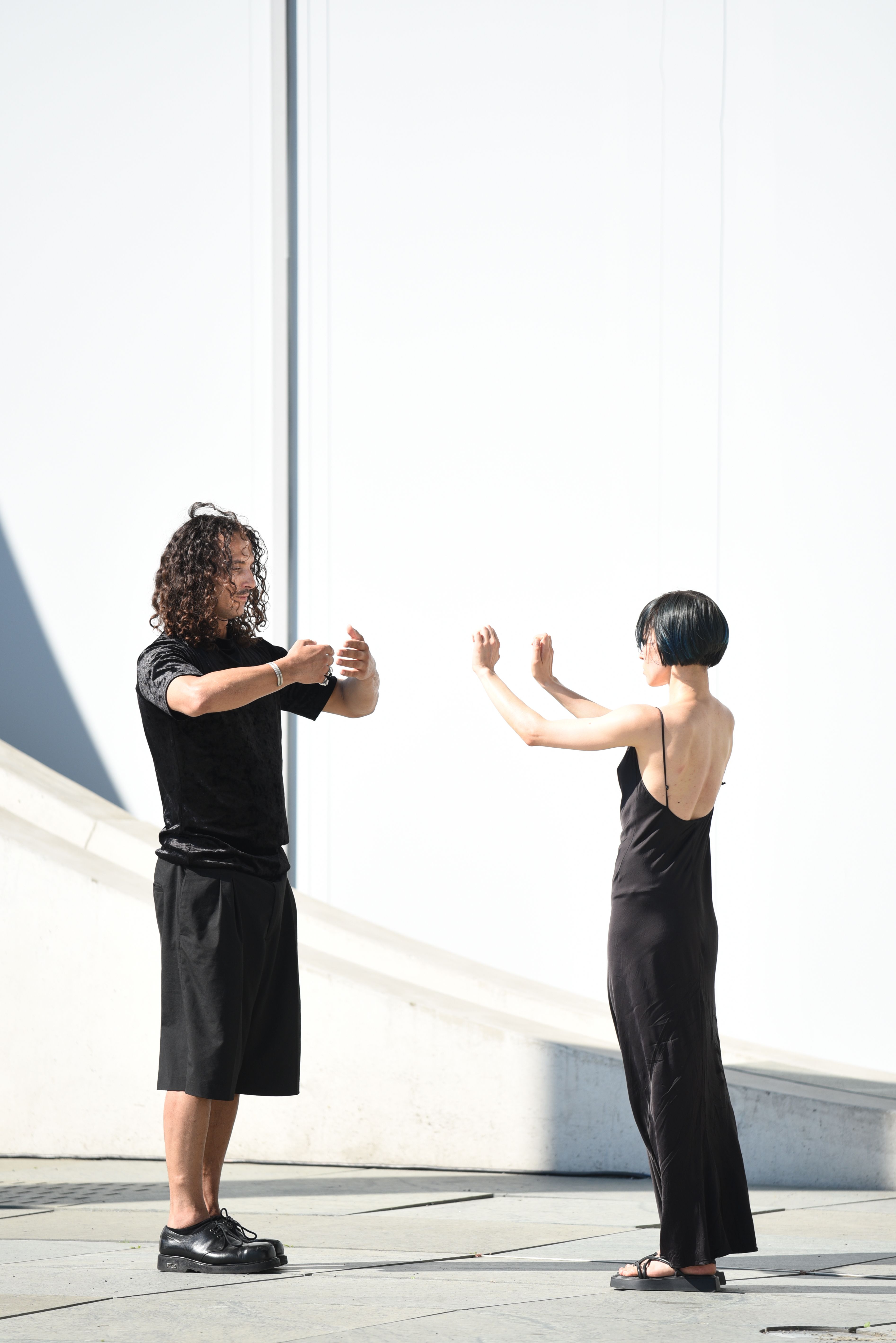 Side View of a Man and a Woman Showing Hand Gestures to Each Other by a ...
