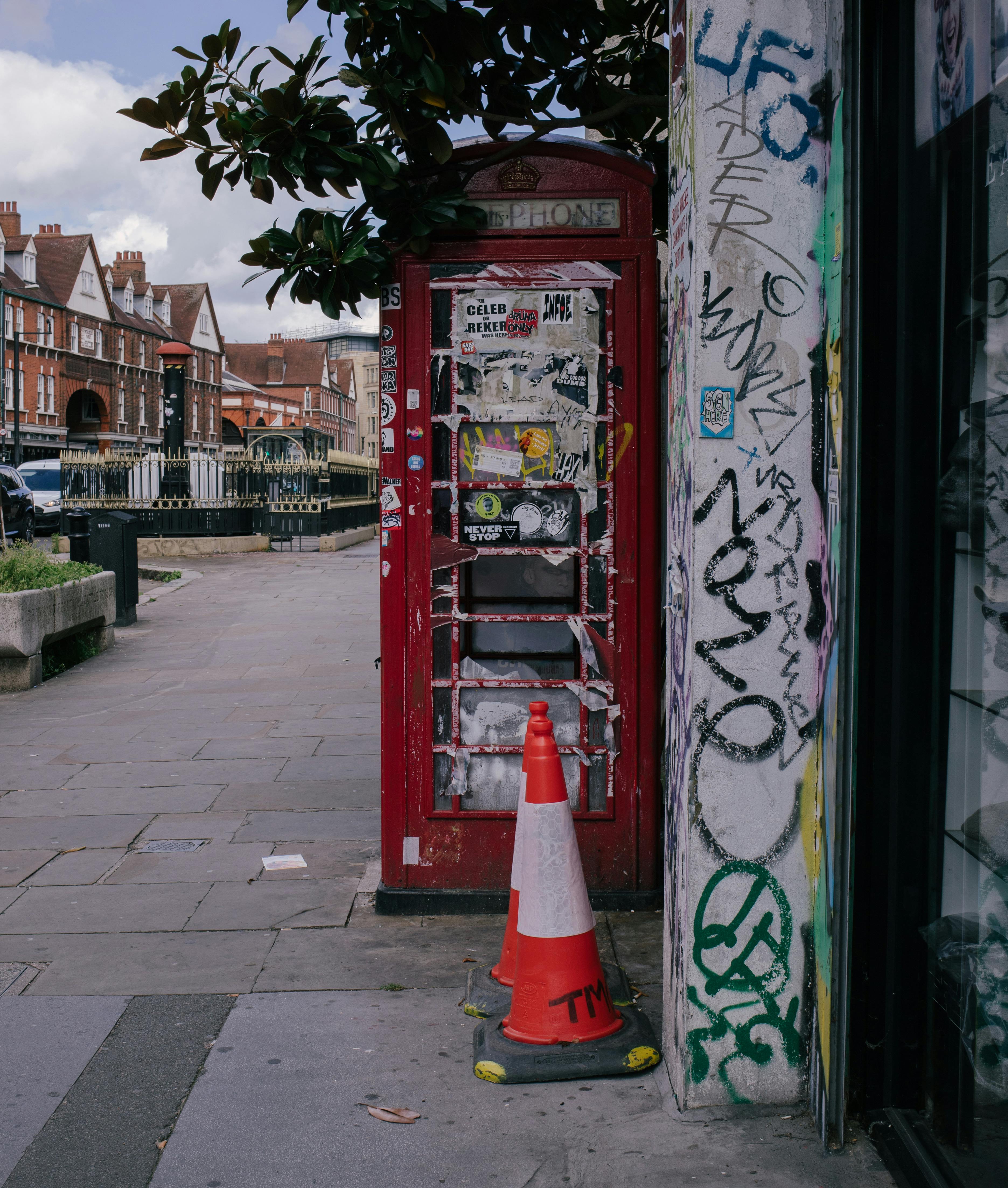 Red Telephone Booth on the Sidewalk With Snow · Free Stock Photo