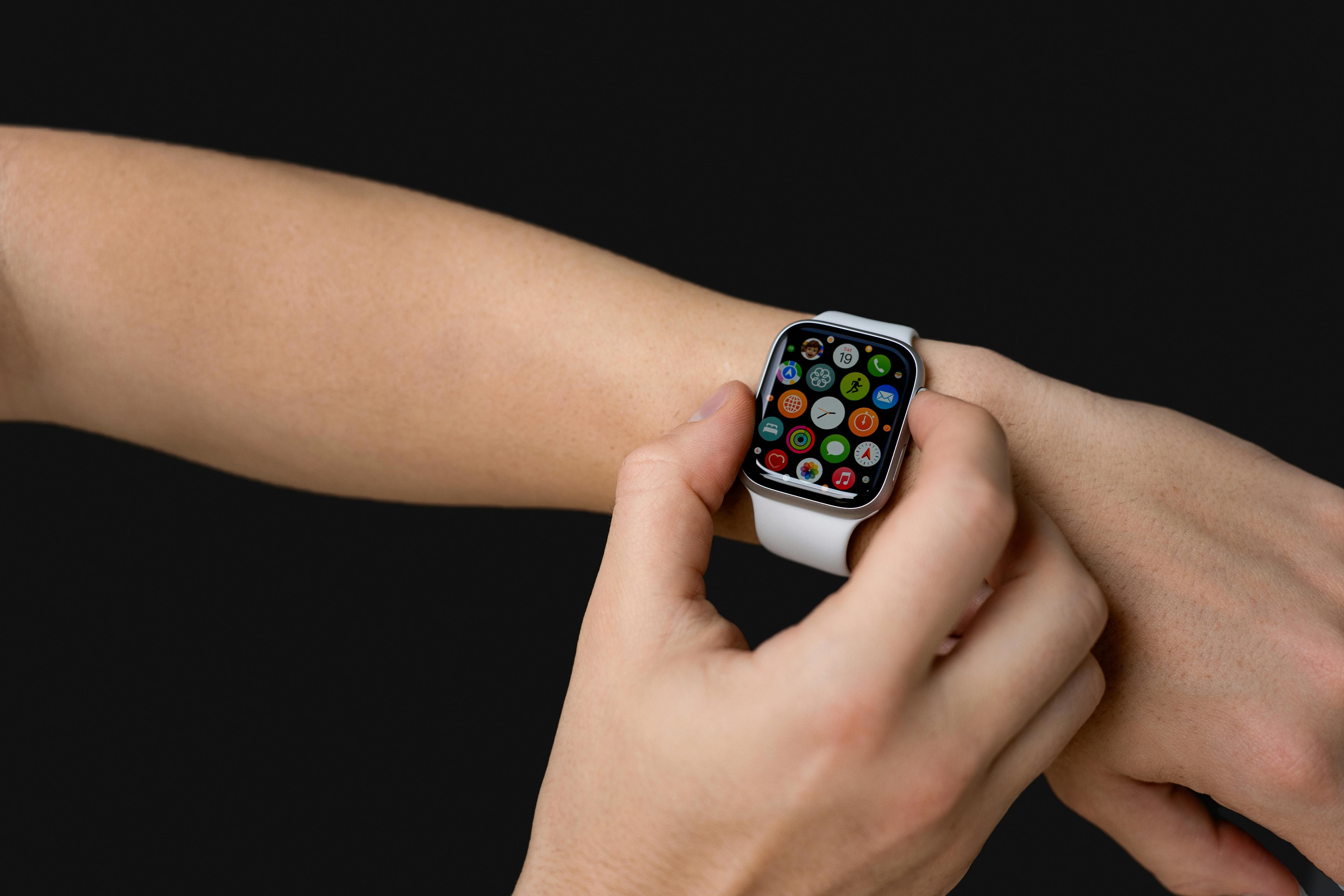 A person holding an apple watch on their wrist · Free Stock Photo