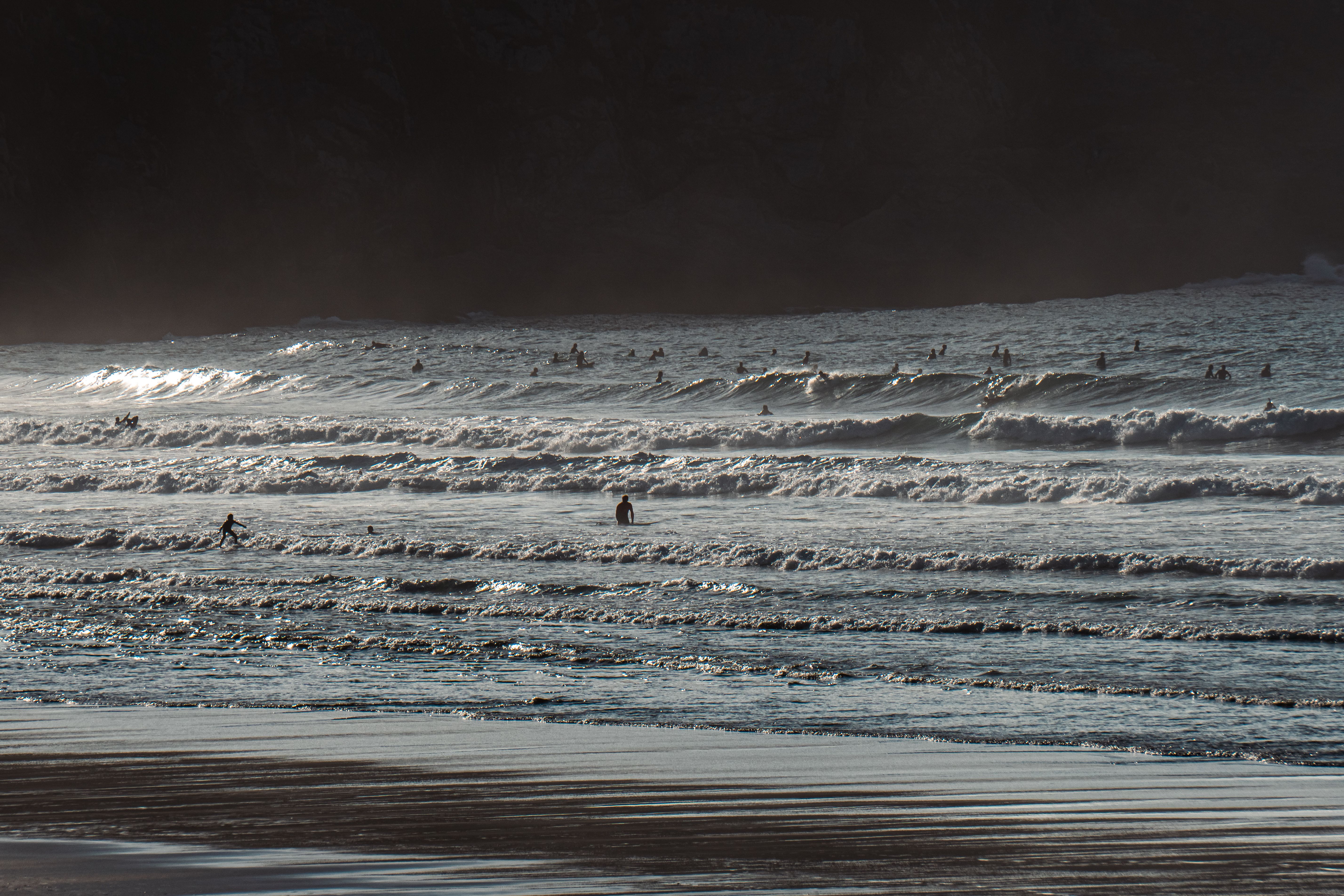People Surfing in the Tides · Free Stock Photo