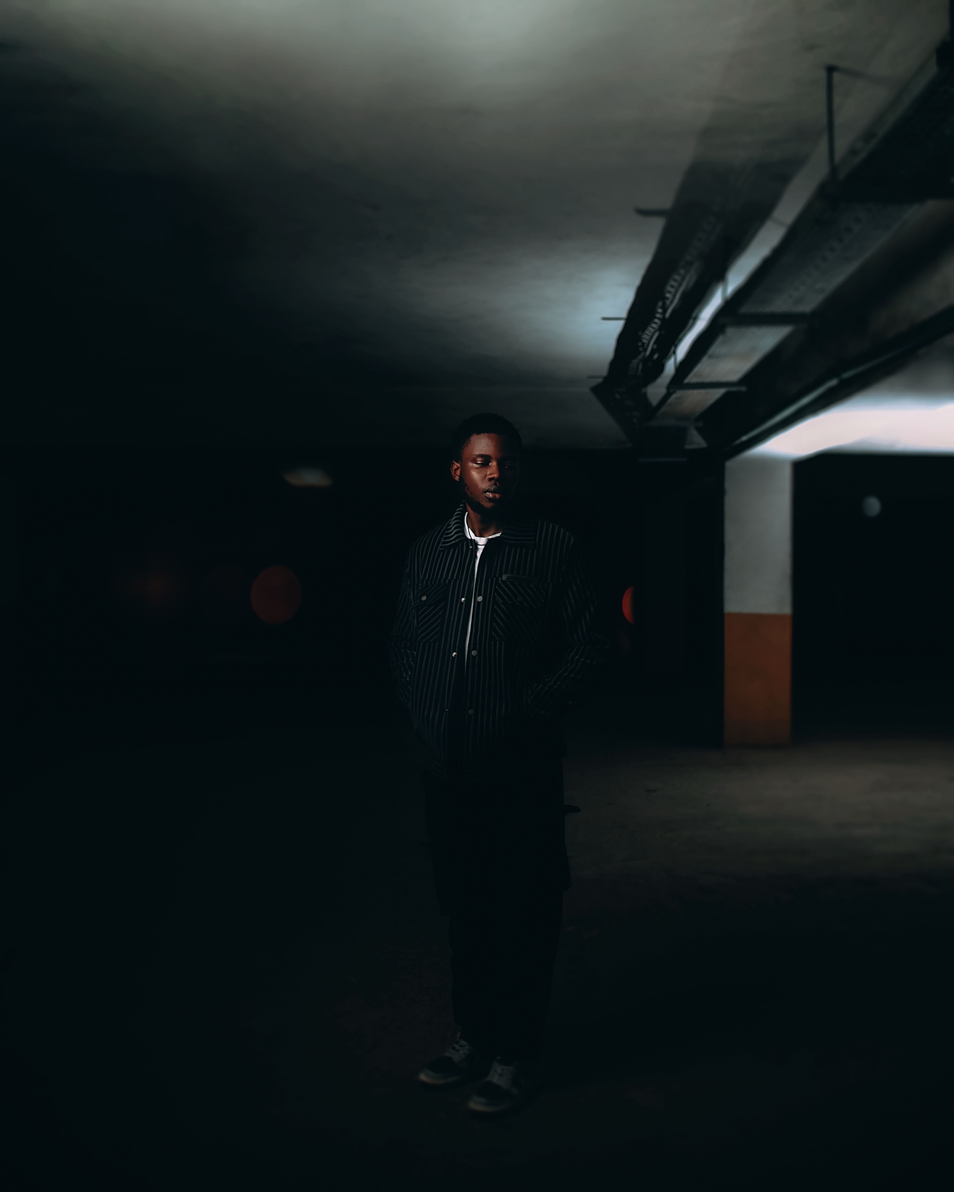 Man Posing in Darkness on Underground Parking · Free Stock Photo