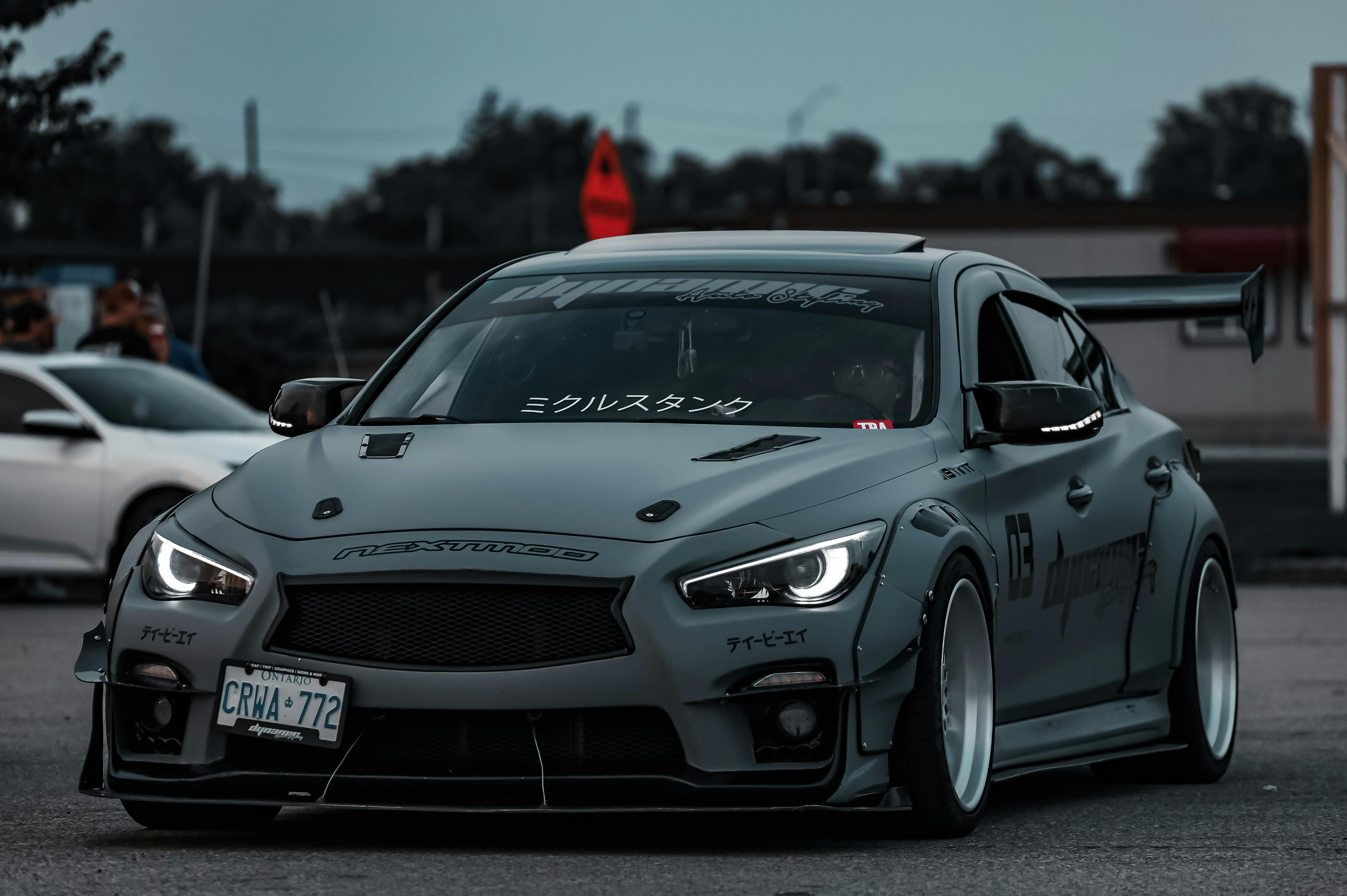 Grey Infinity Sports Car on a Parking Lot · Free Stock Photo