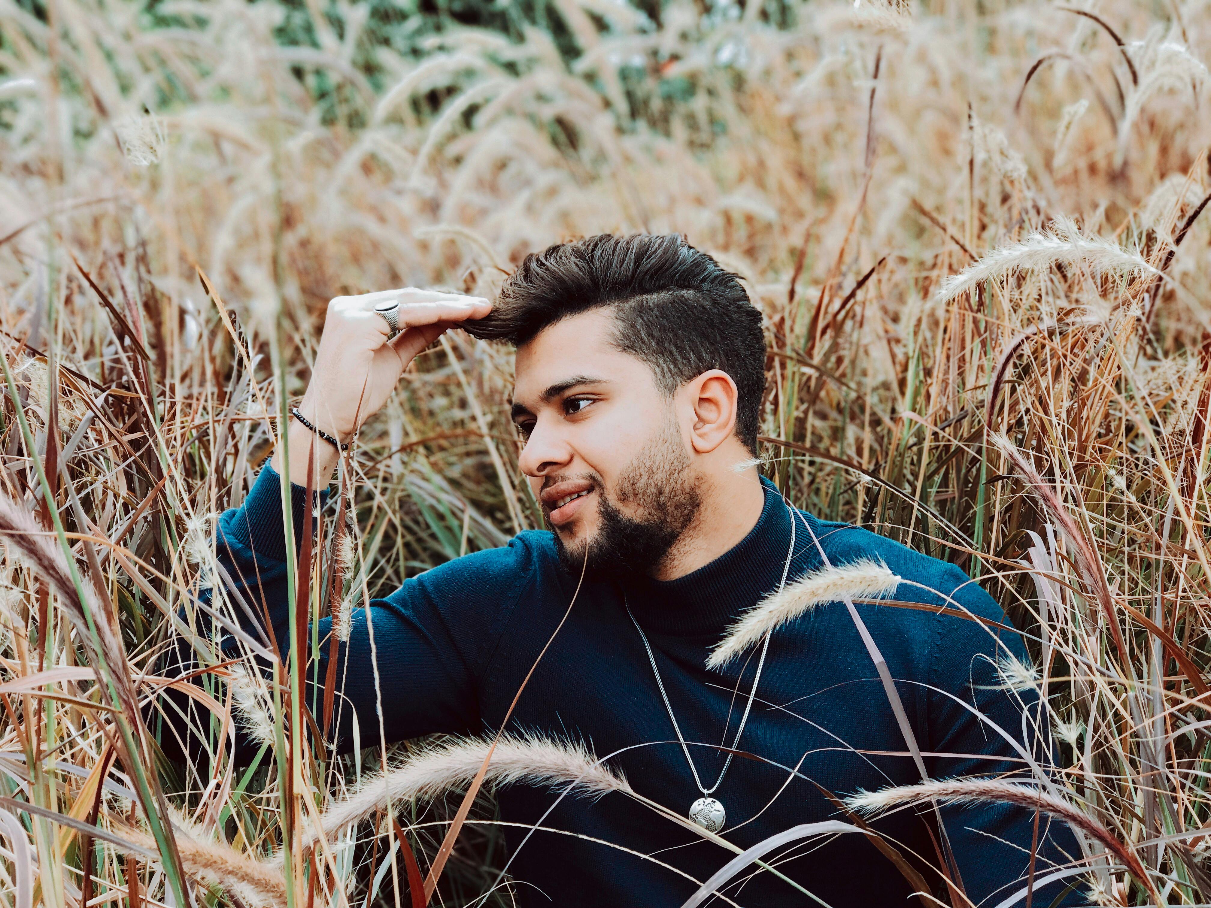 Man Holding Dslr Camera in Crouch Position · Free Stock Photo