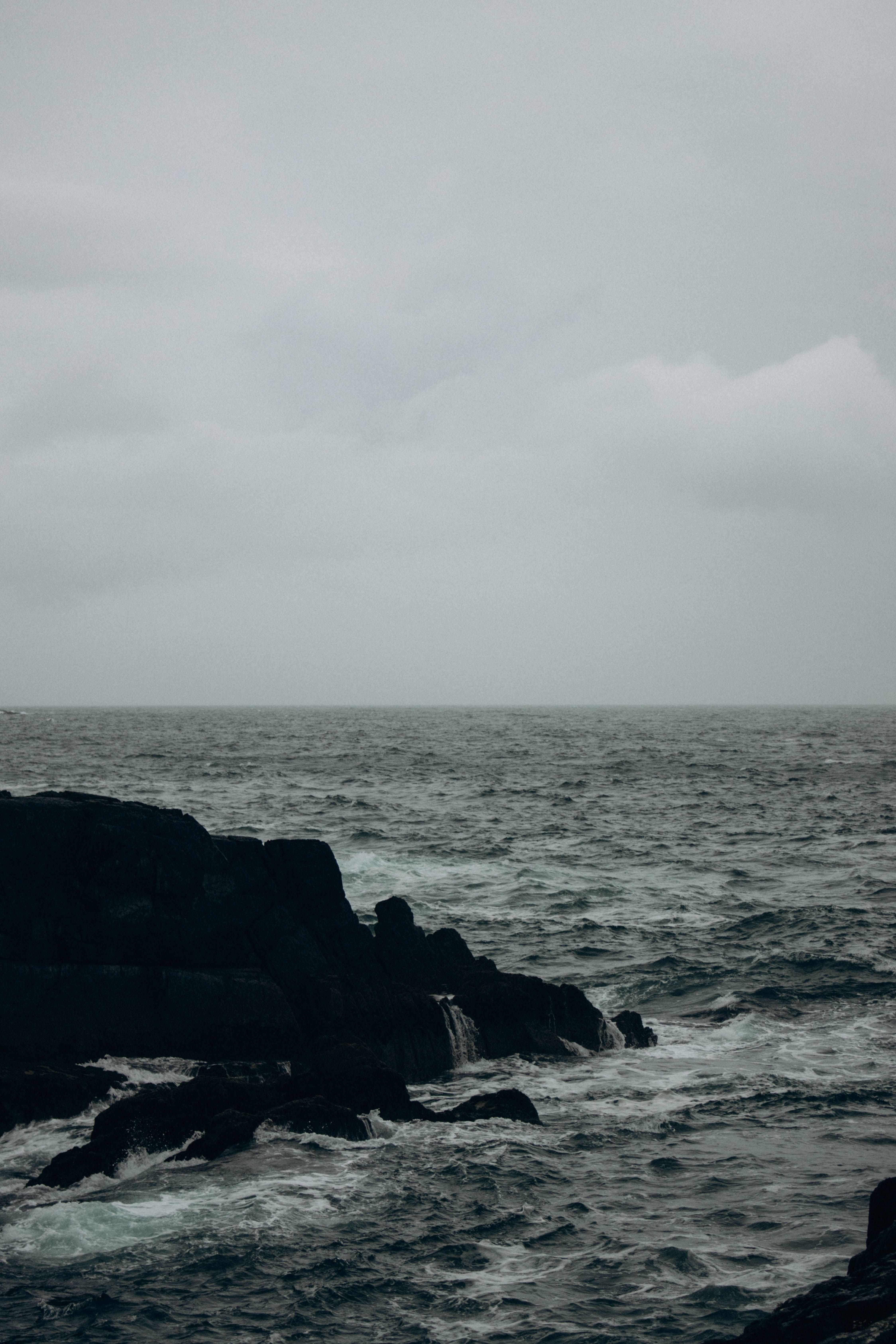 Overcast over Rocks on Sea Shore · Free Stock Photo