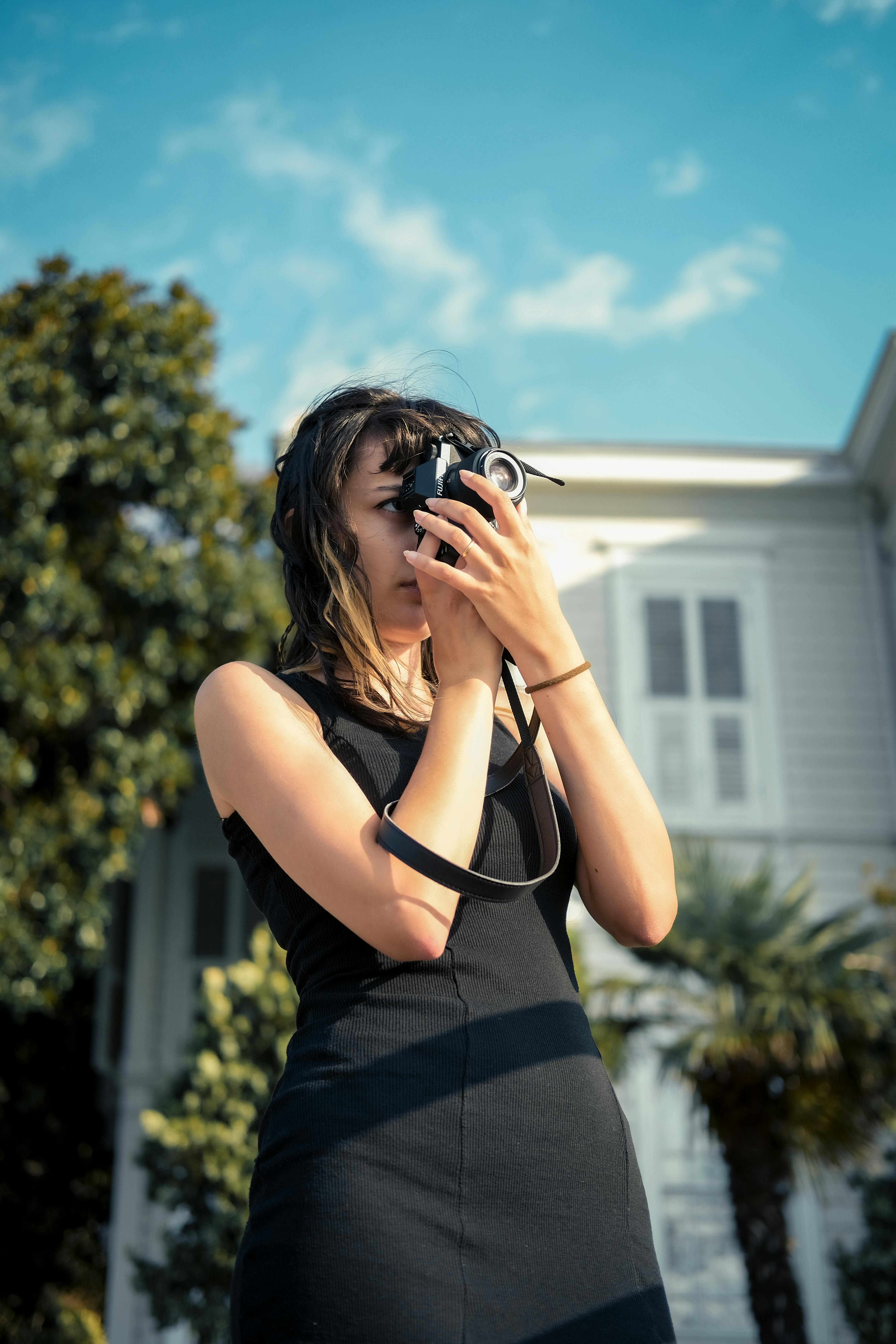 Woman in Black Tight Dress Photographing · Free Stock Photo