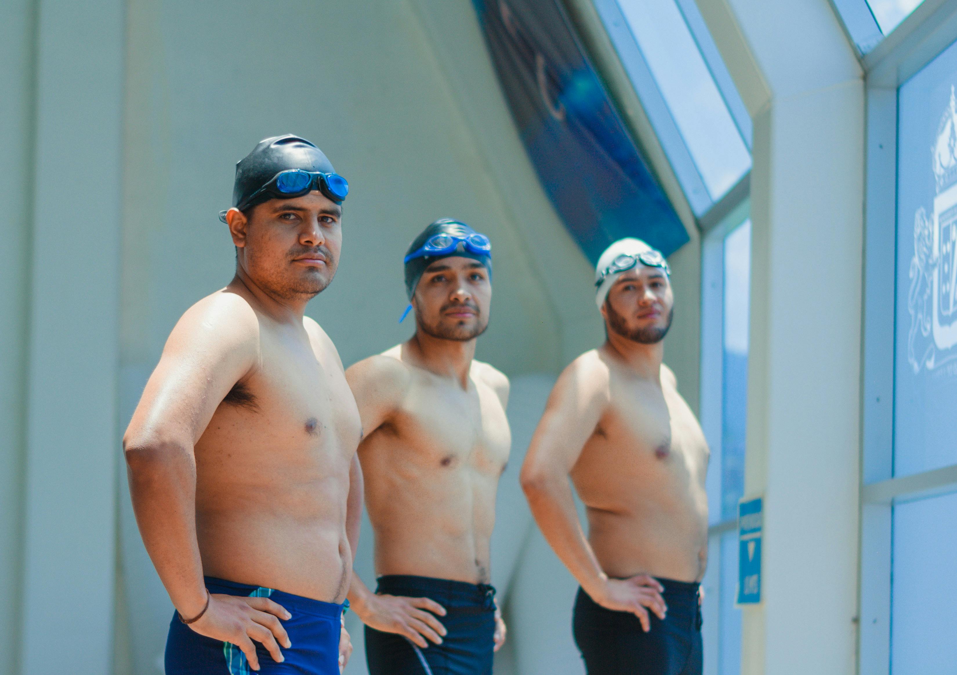 Three Swimmers Posing · Free Stock Photo