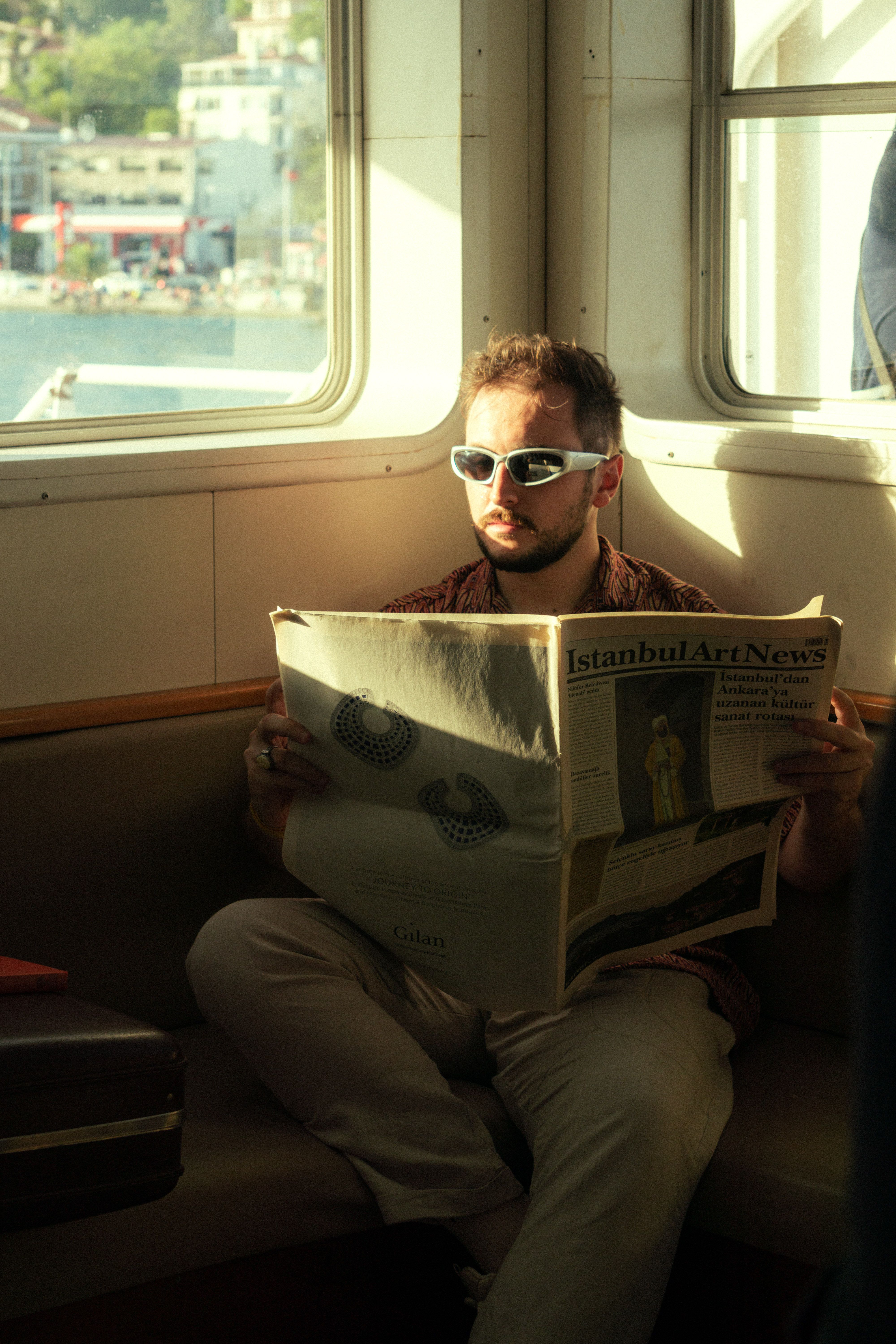 Brunette Woman in Dress Reading Newspaper on Ferry · Free Stock Photo