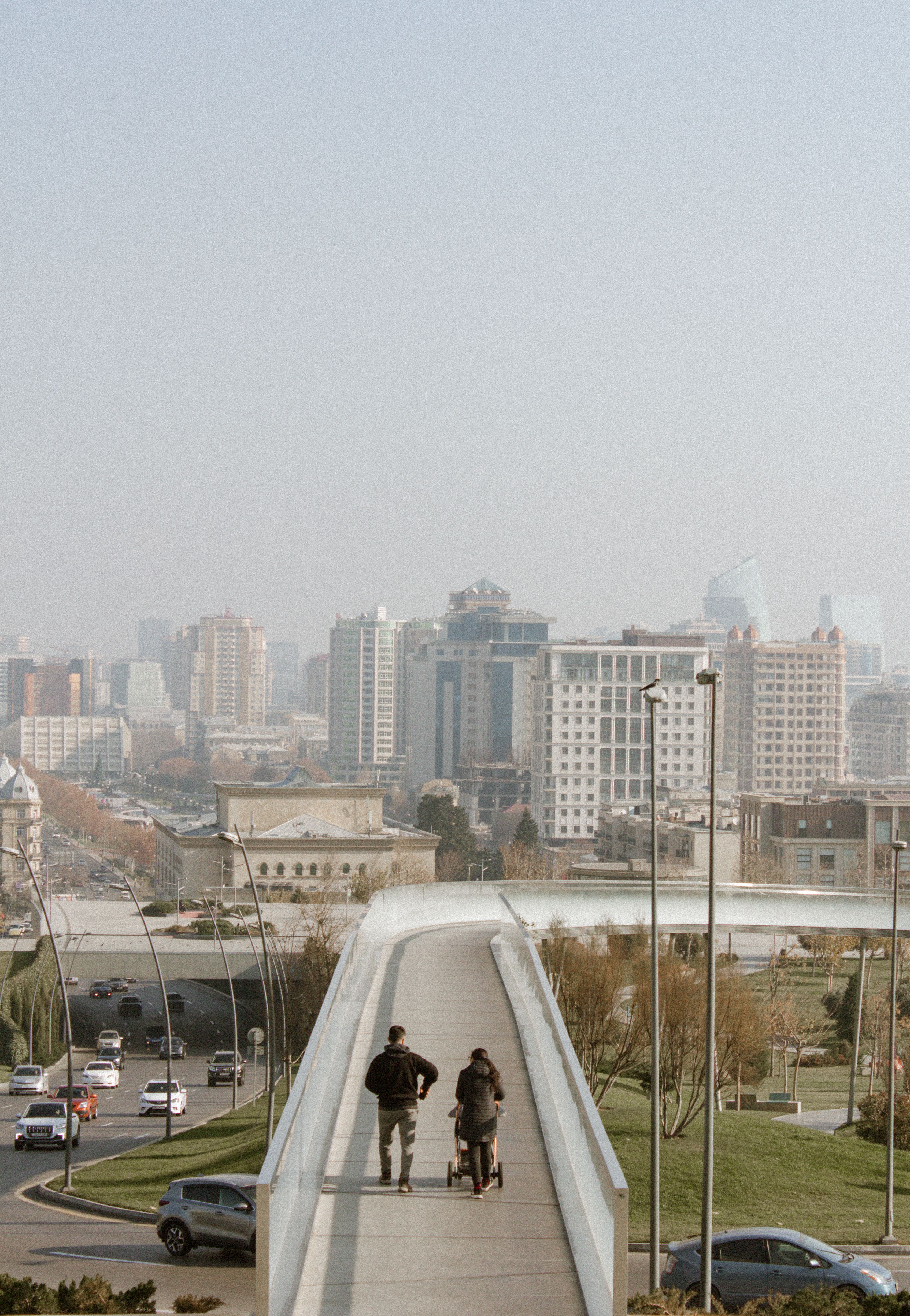 Couple Walking on a Footbridge in a City · Free Stock Photo