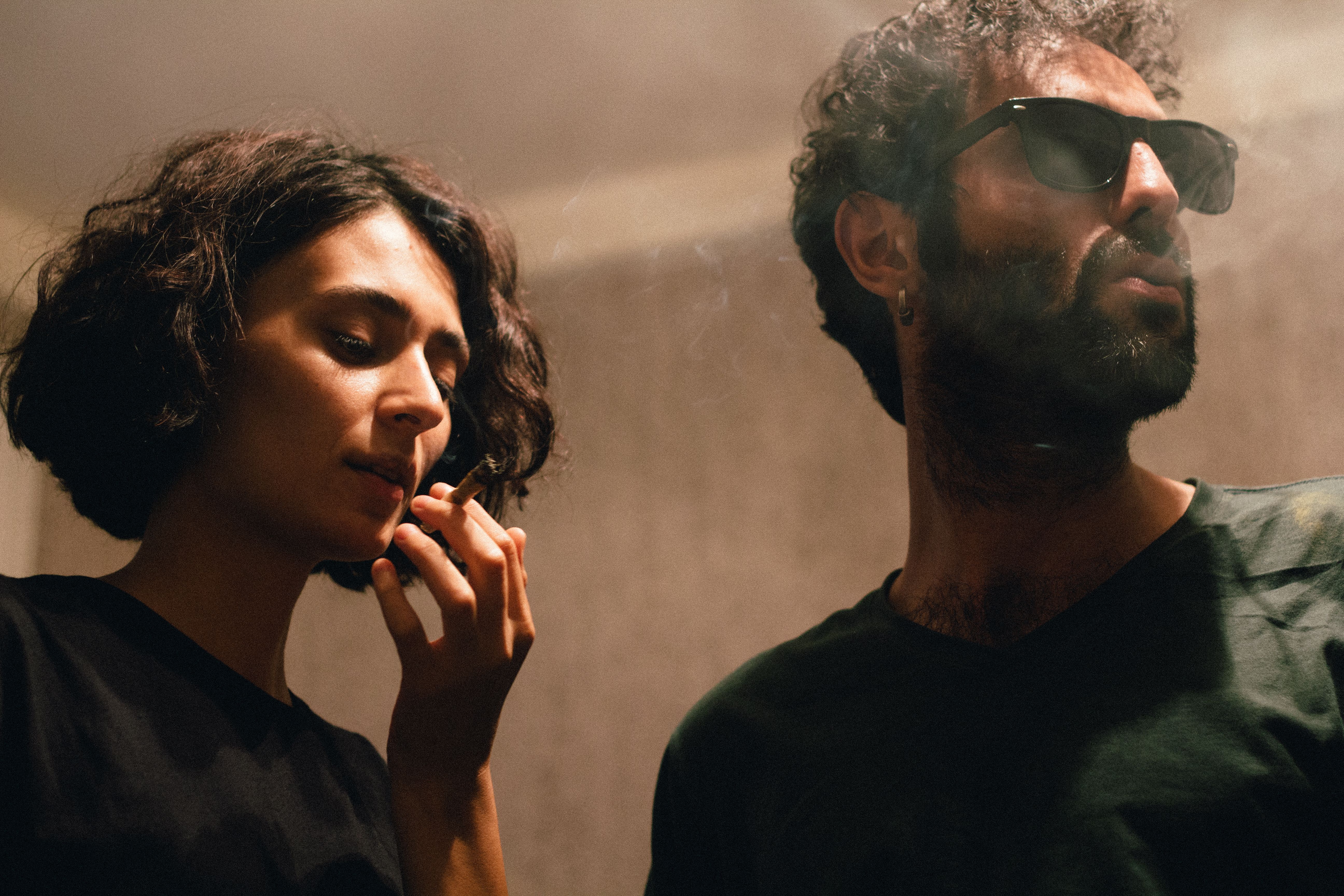 Brunette Woman and Man Smoking in a Room · Free Stock Photo