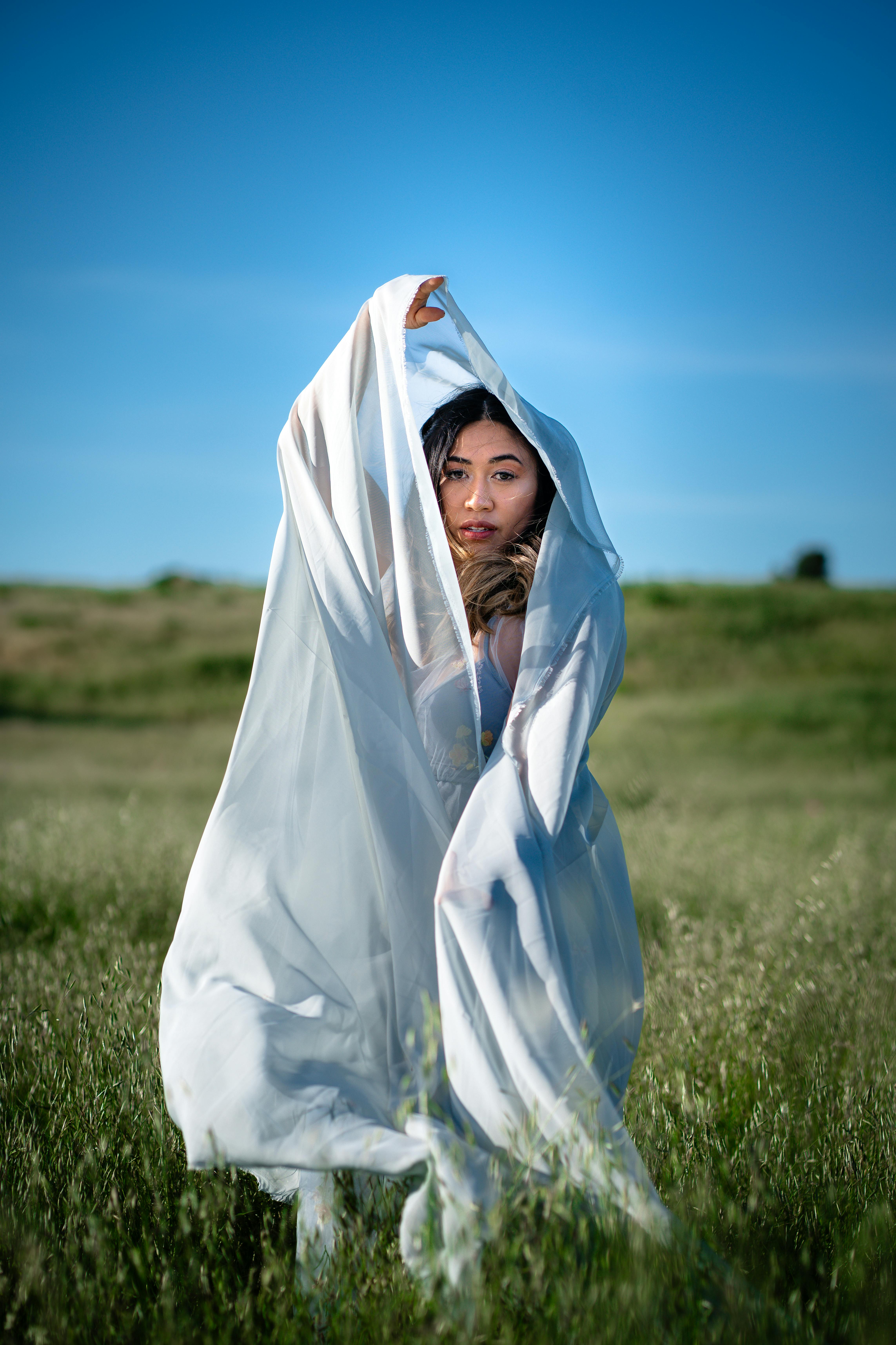 Woman Wrapped in a White Sheet in a Meadow · Free Stock Photo