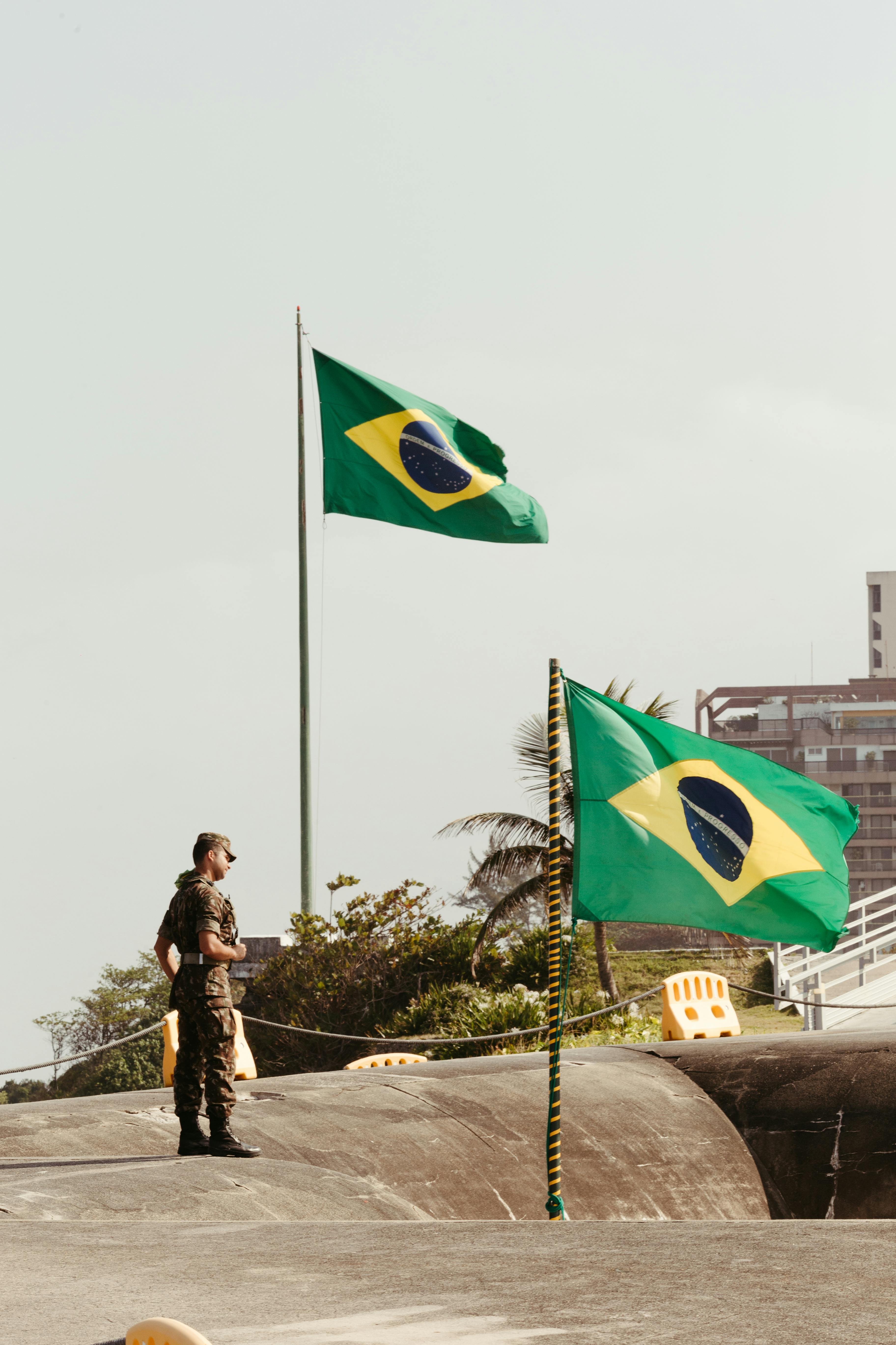Soldier Standing near Flags of Brazil · Free Stock Photo