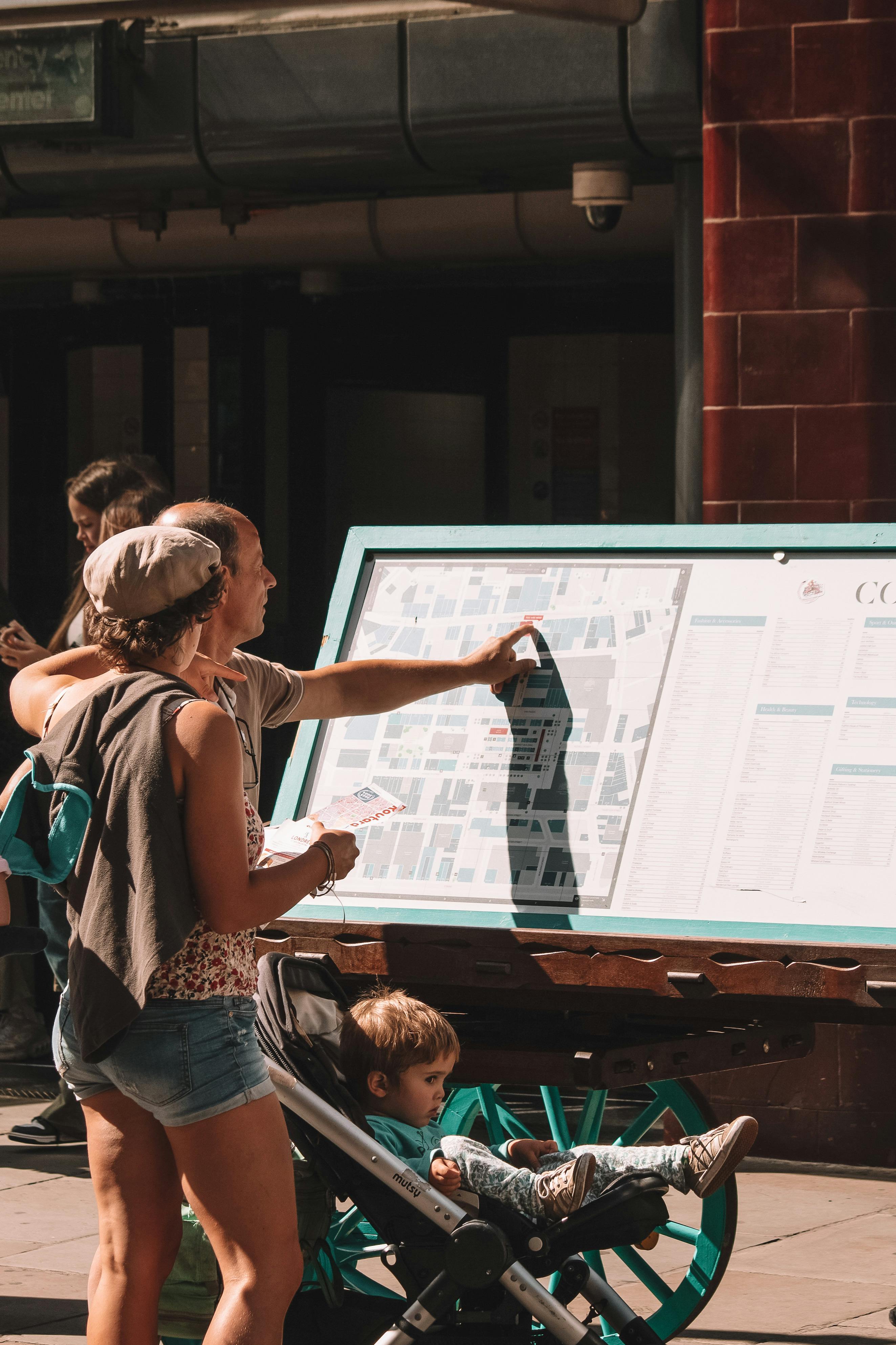 Man and Woman Looking at the Map of the City · Free Stock Photo