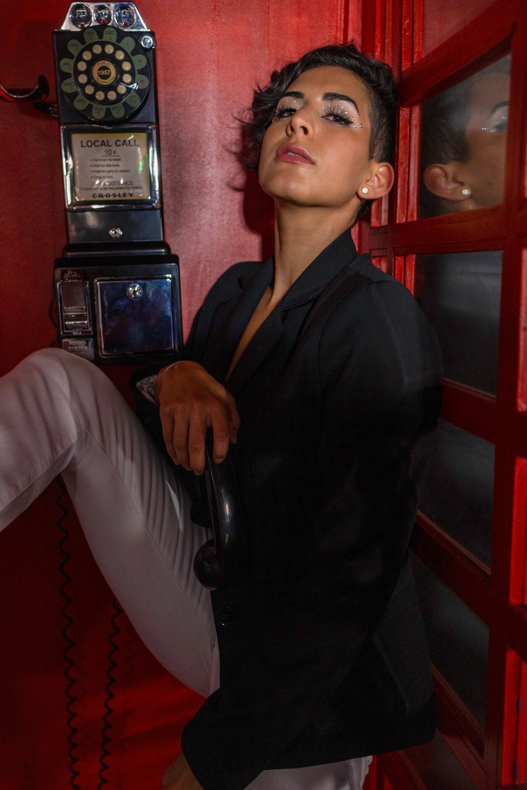 Young Woman Posing in a Vintage Payphone · Free Stock Photo
