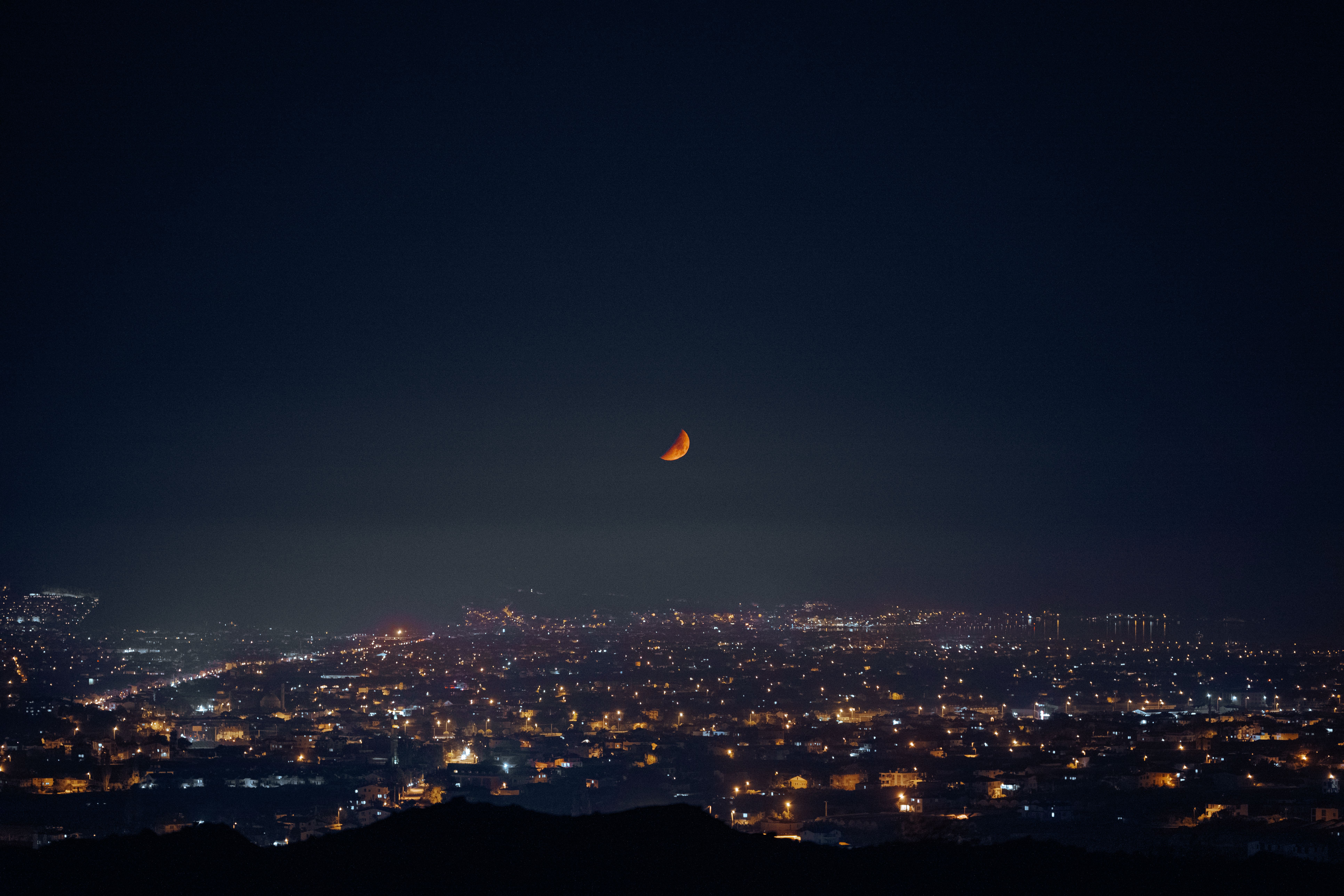 Crescent Yellow Moon over City at Night · Free Stock Photo
