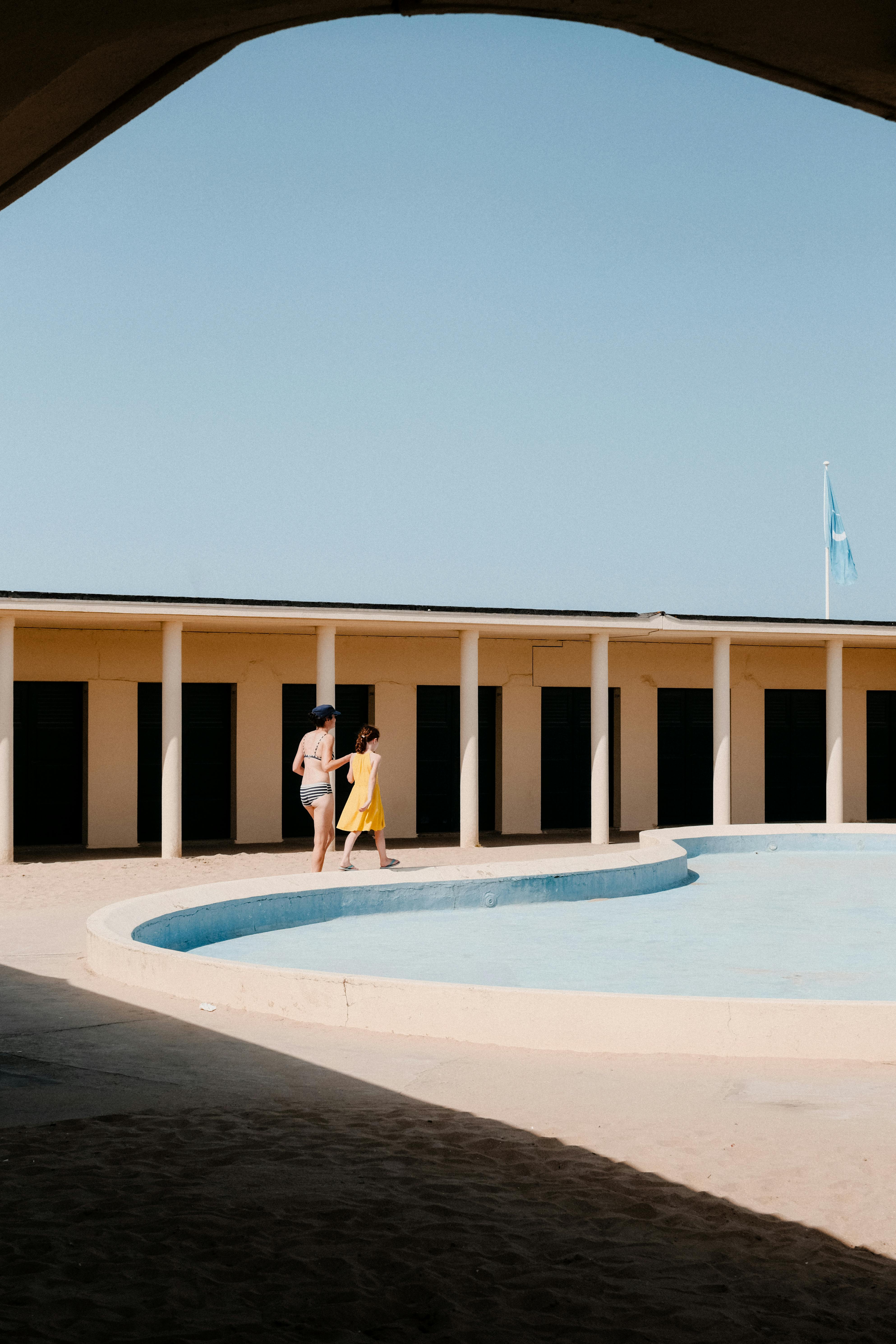 Woman and Girl Walking next to Swimming Pool · Free Stock Photo
