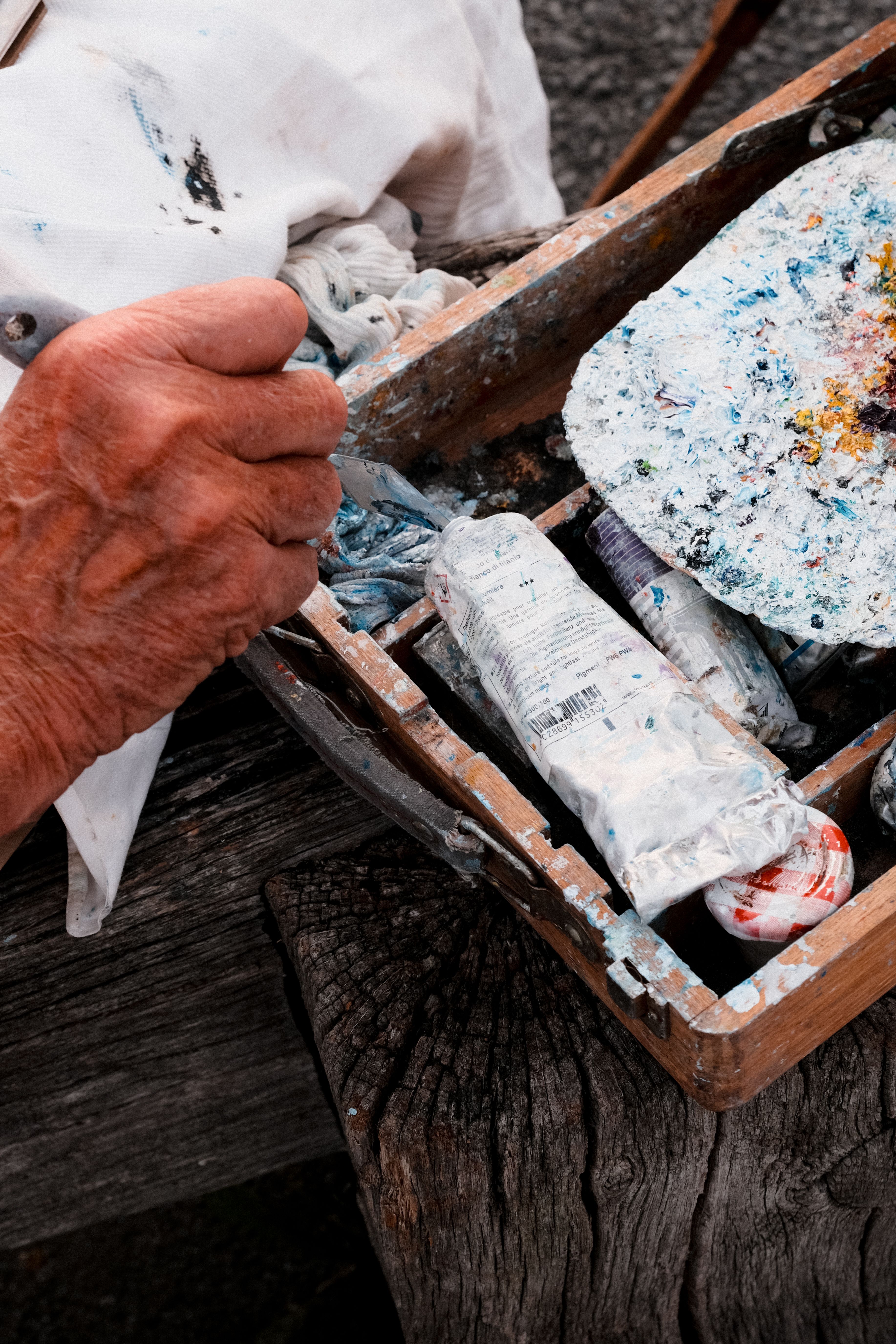 Hand of a Painter by his Equipment · Free Stock Photo