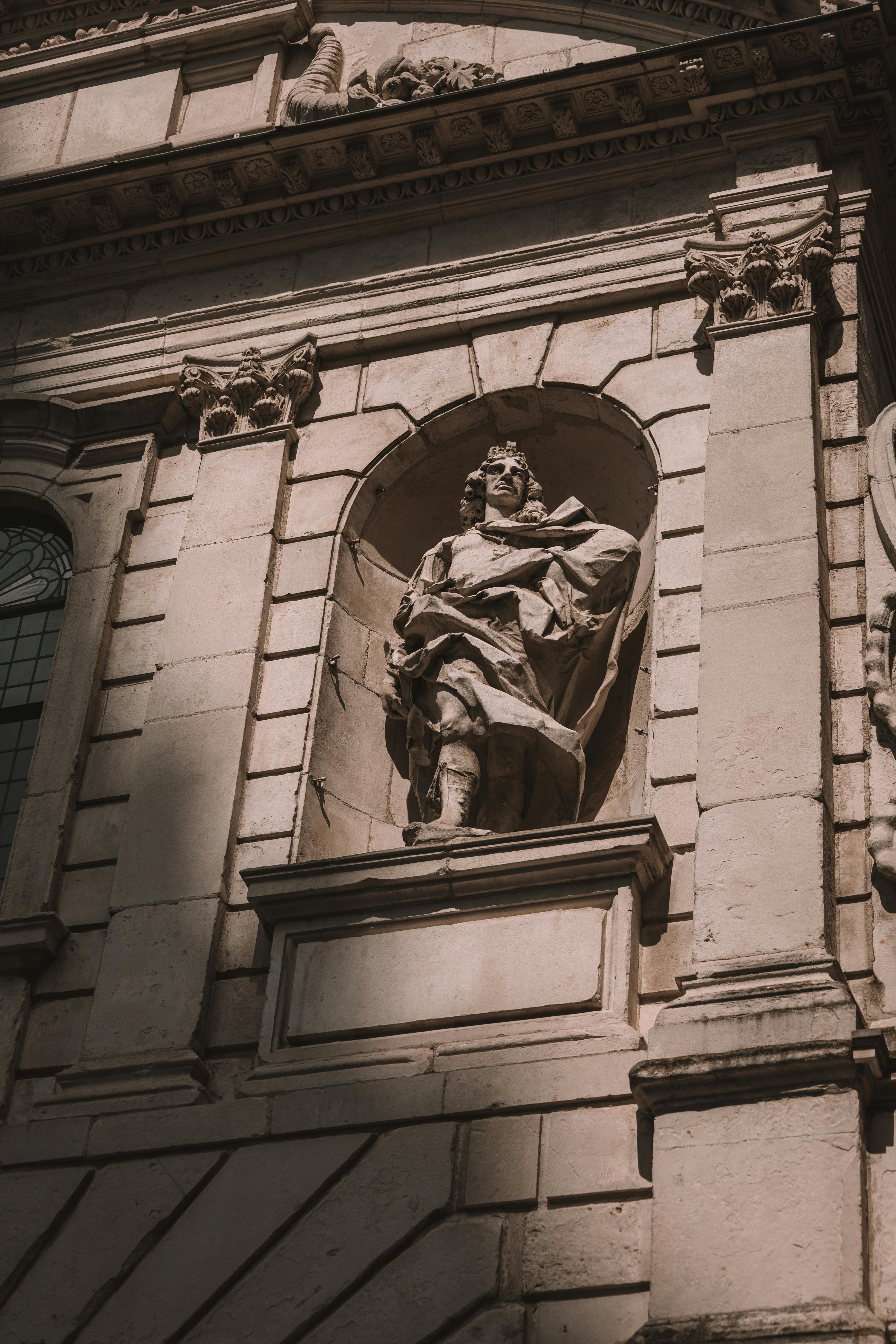 Sculpture on Building Wall · Free Stock Photo