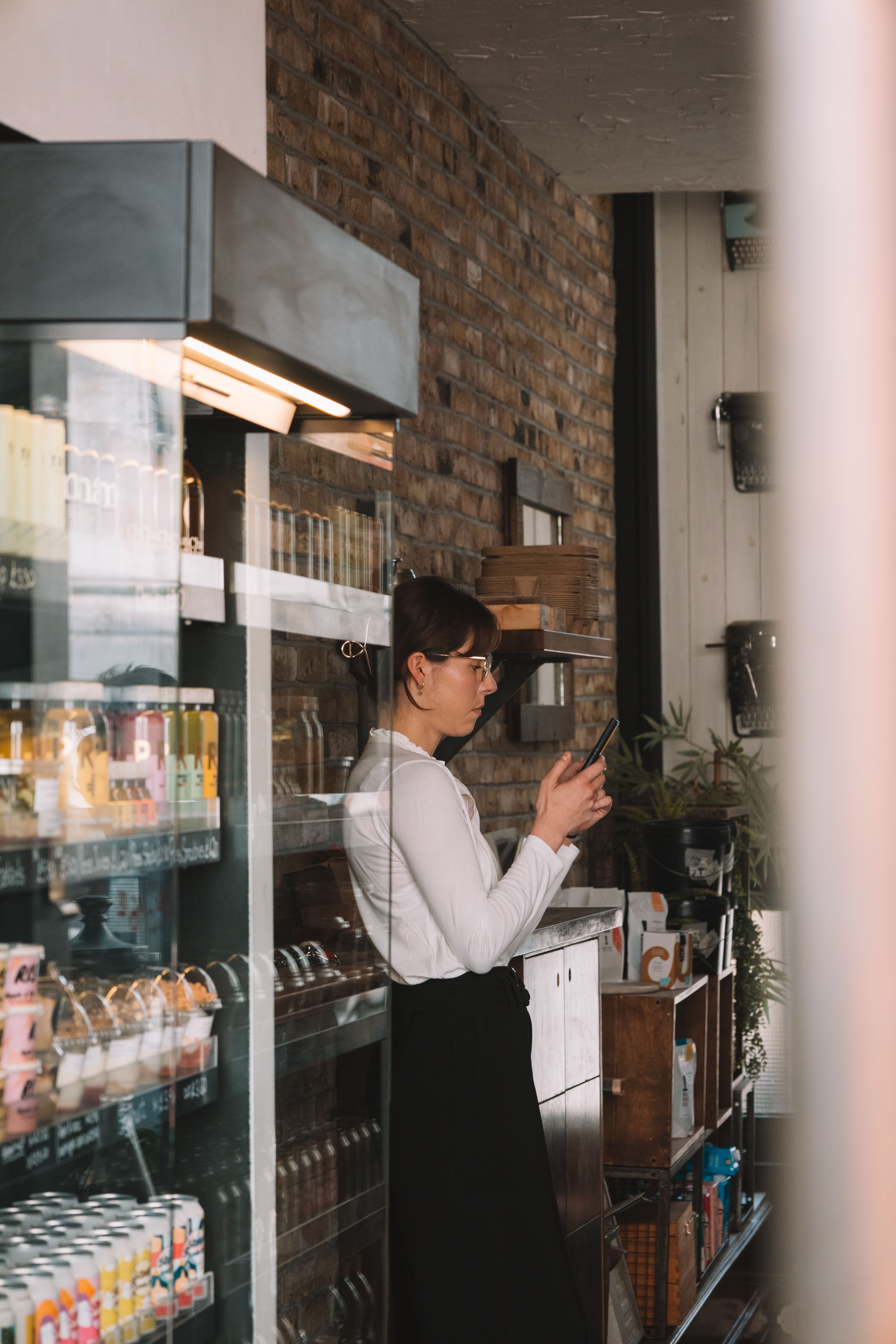 Woman Standing in a Restaurant Bar · Free Stock Photo