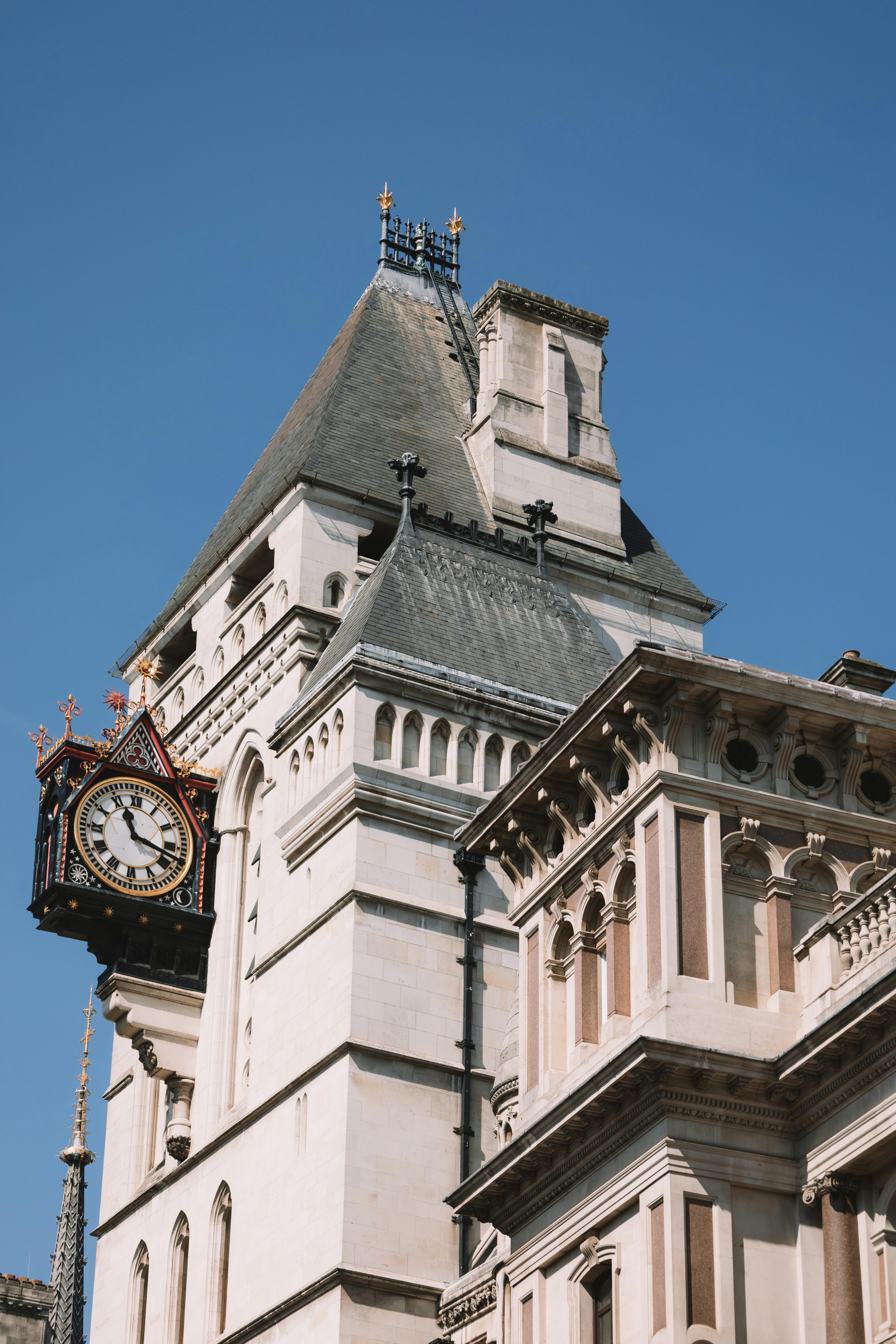 Low Angle Shot of a Neo-Gothic Clock Tower · Free Stock Photo