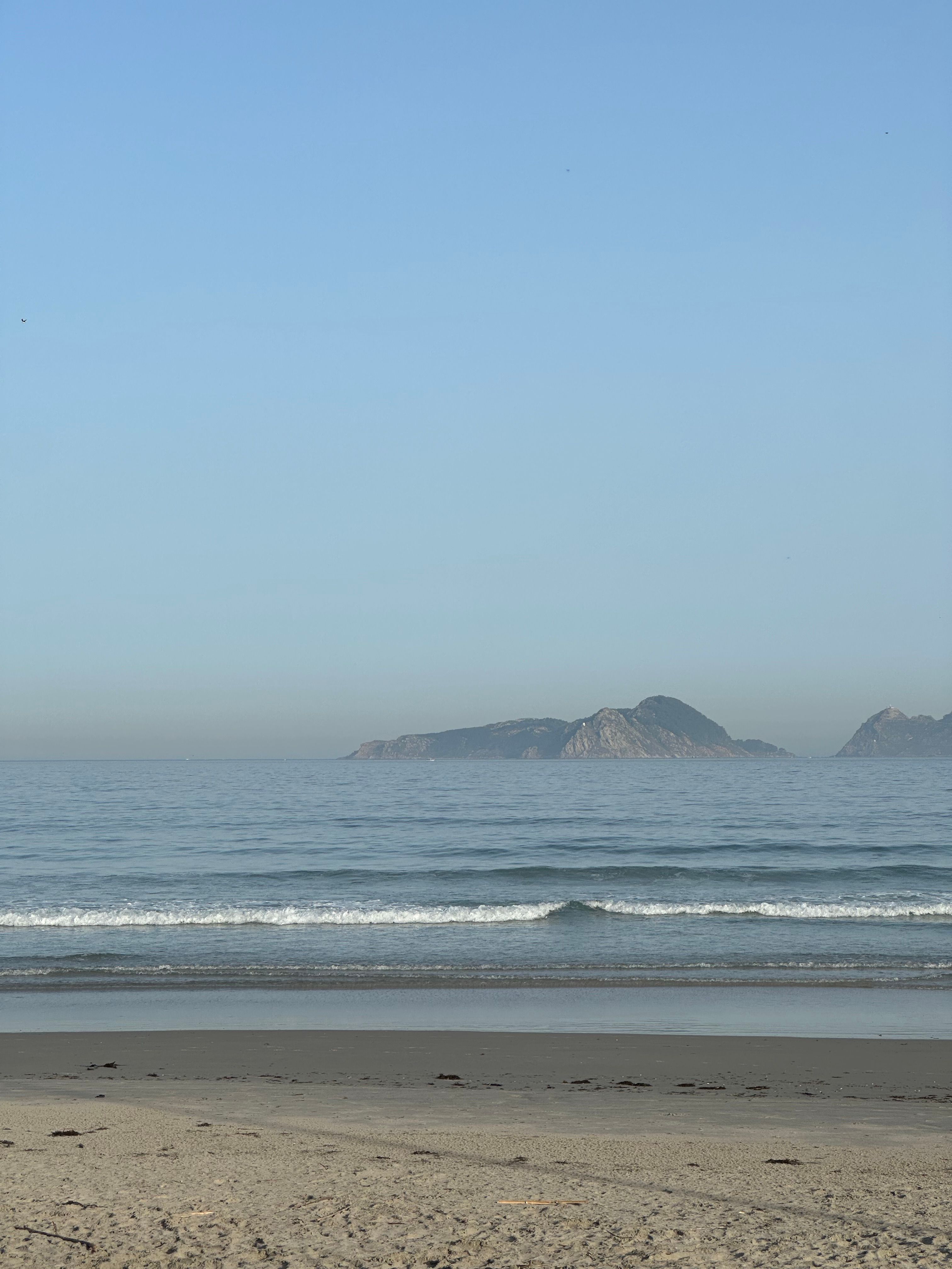 Placid Hazy Morning Seascape with Distant Rocks · Free Stock Photo