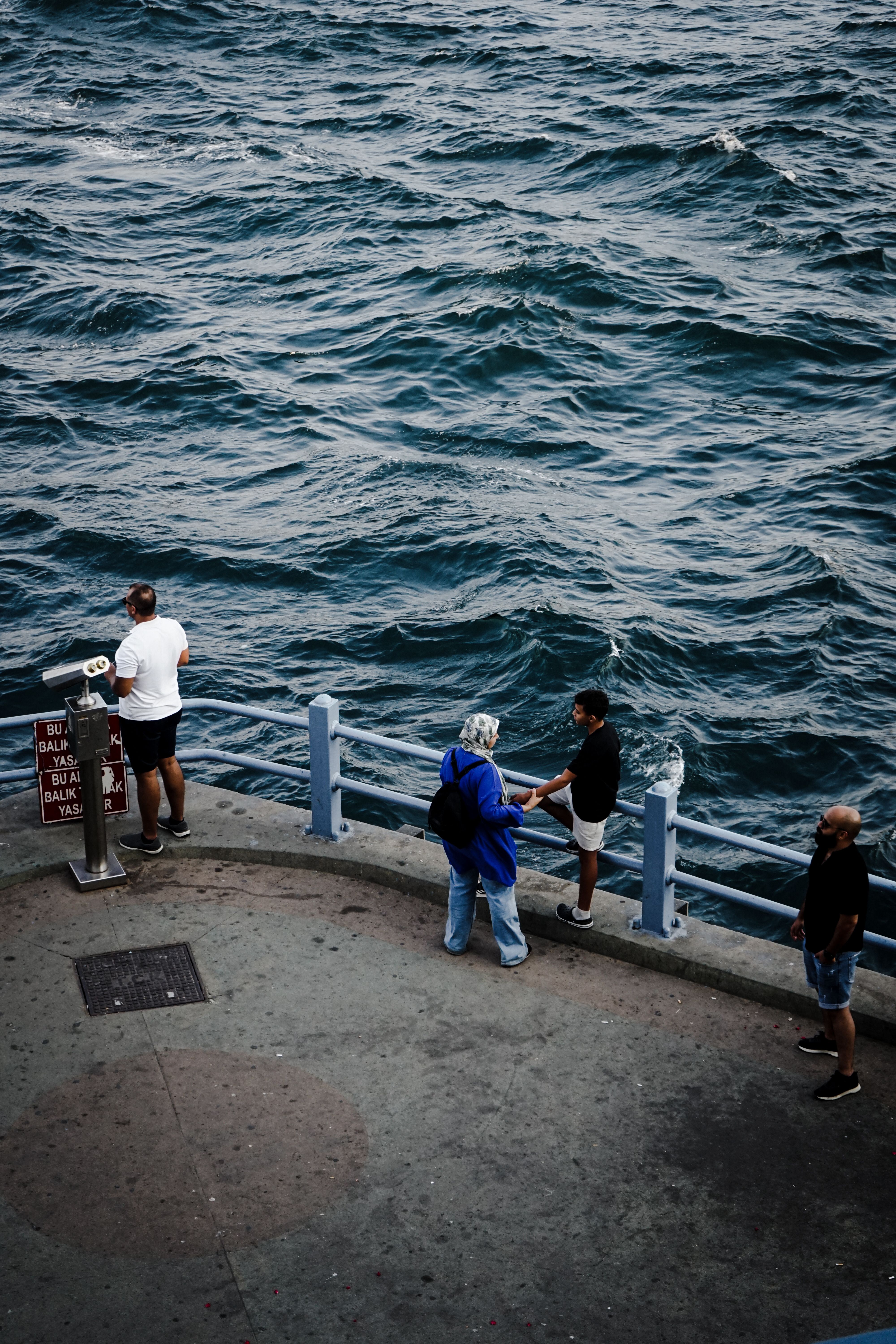 People Standing at a Waterfront Viewpoint · Free Stock Photo
