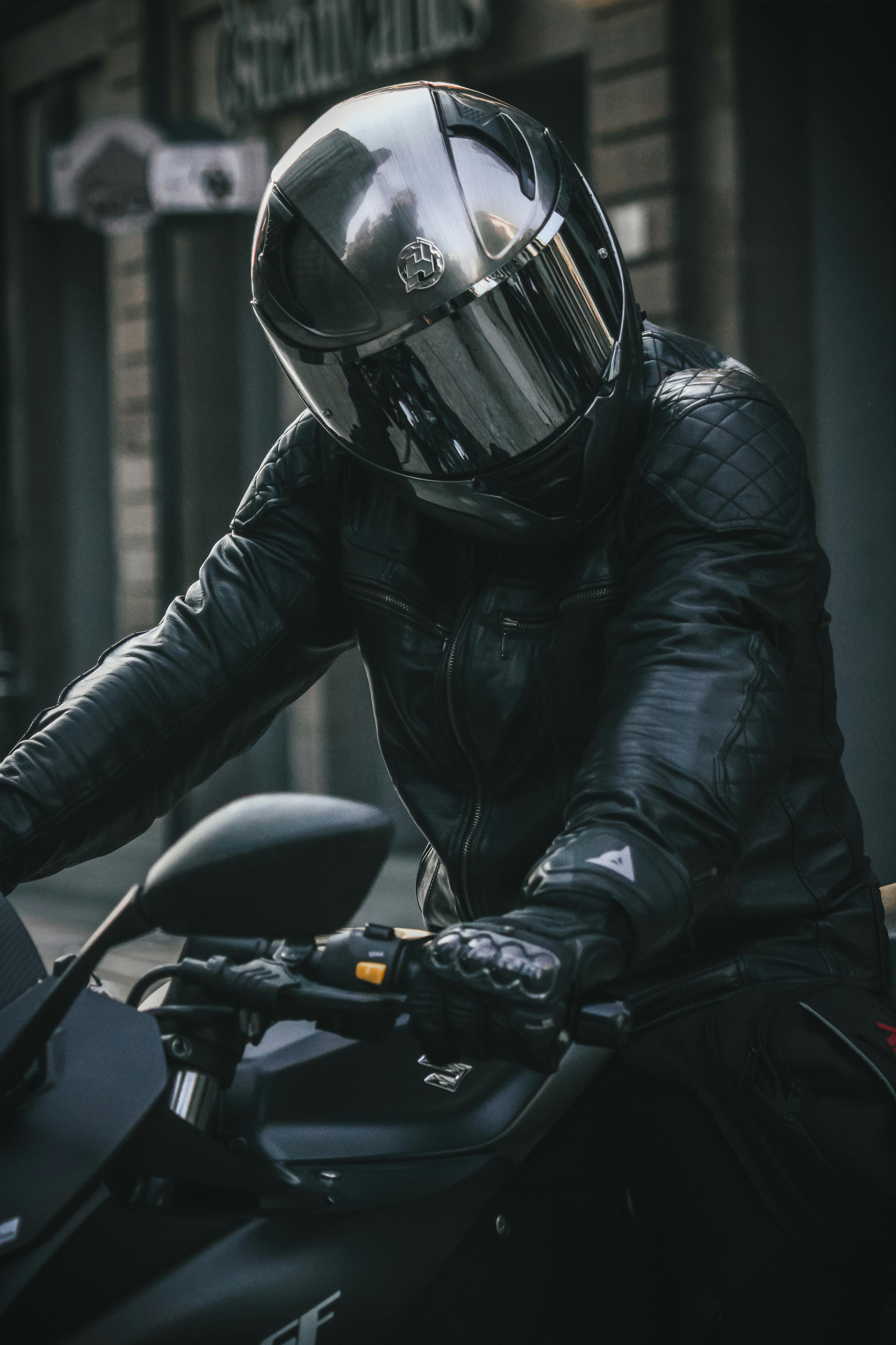 A person wearing a helmet and riding a motorcycle · Free Stock Photo