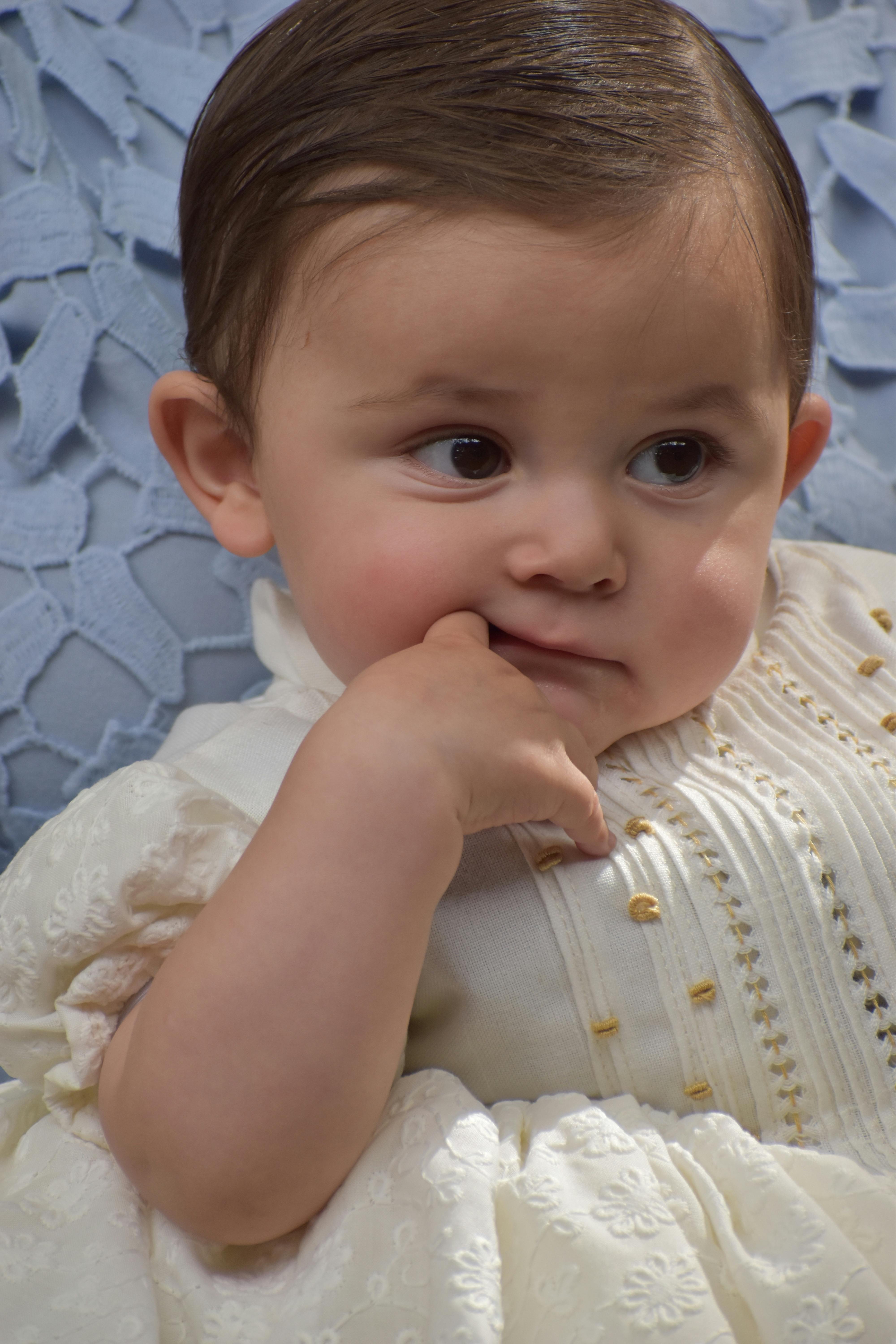 Baby Girl with Finger in Mouth · Free Stock Photo