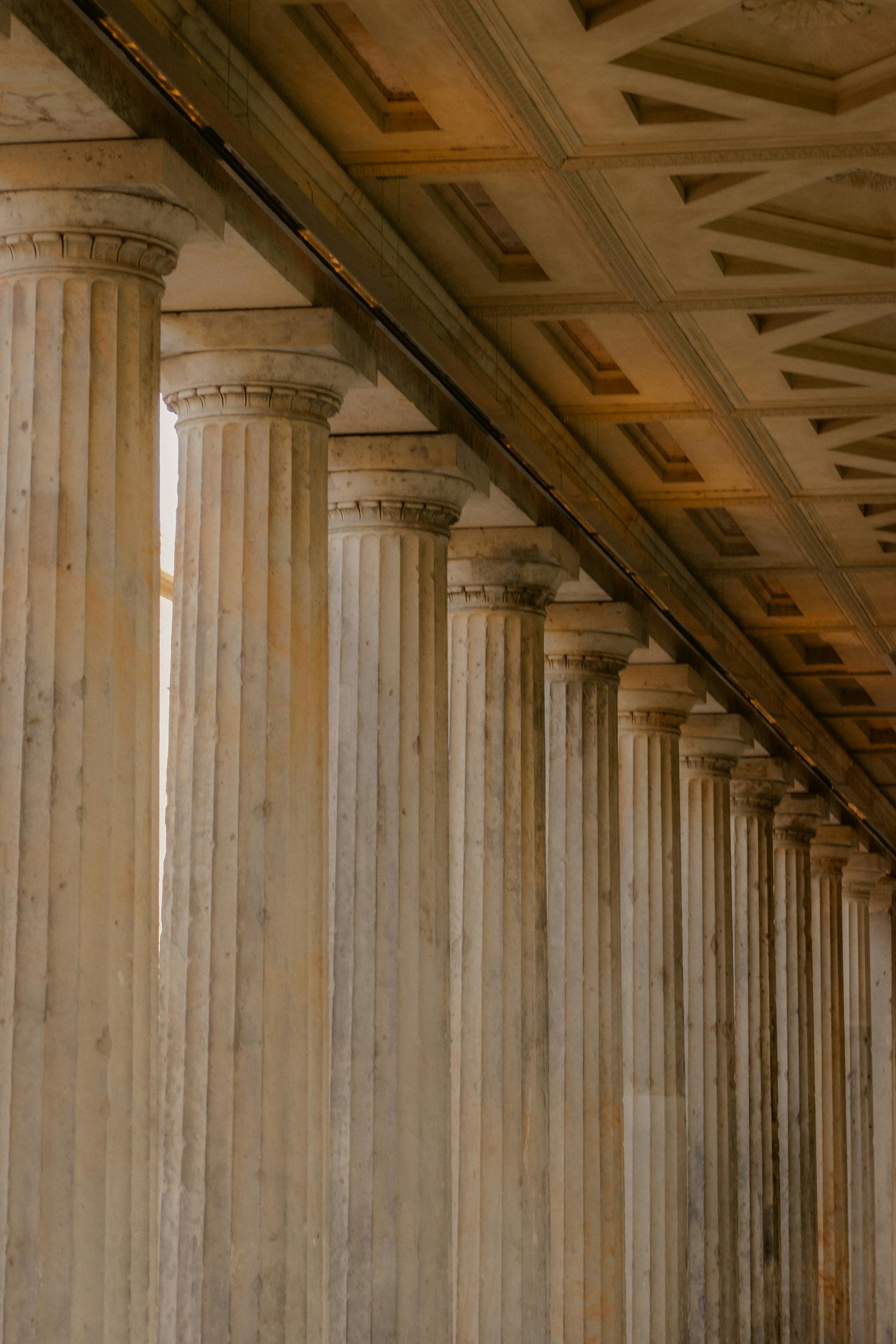 Passersby Between the Colonnades of the Arcade · Free Stock Photo