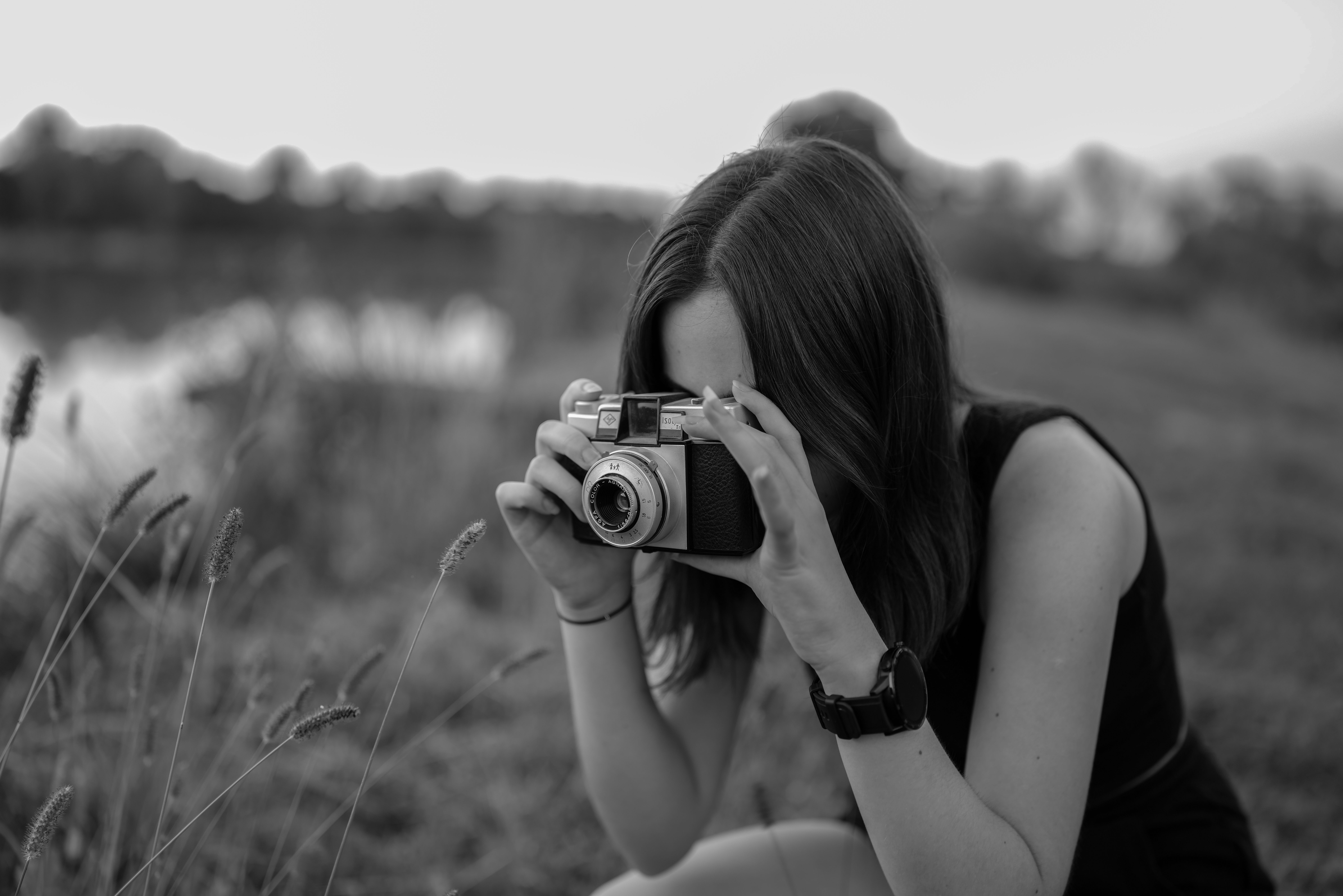 A woman is taking a photo with her camera · Free Stock Photo