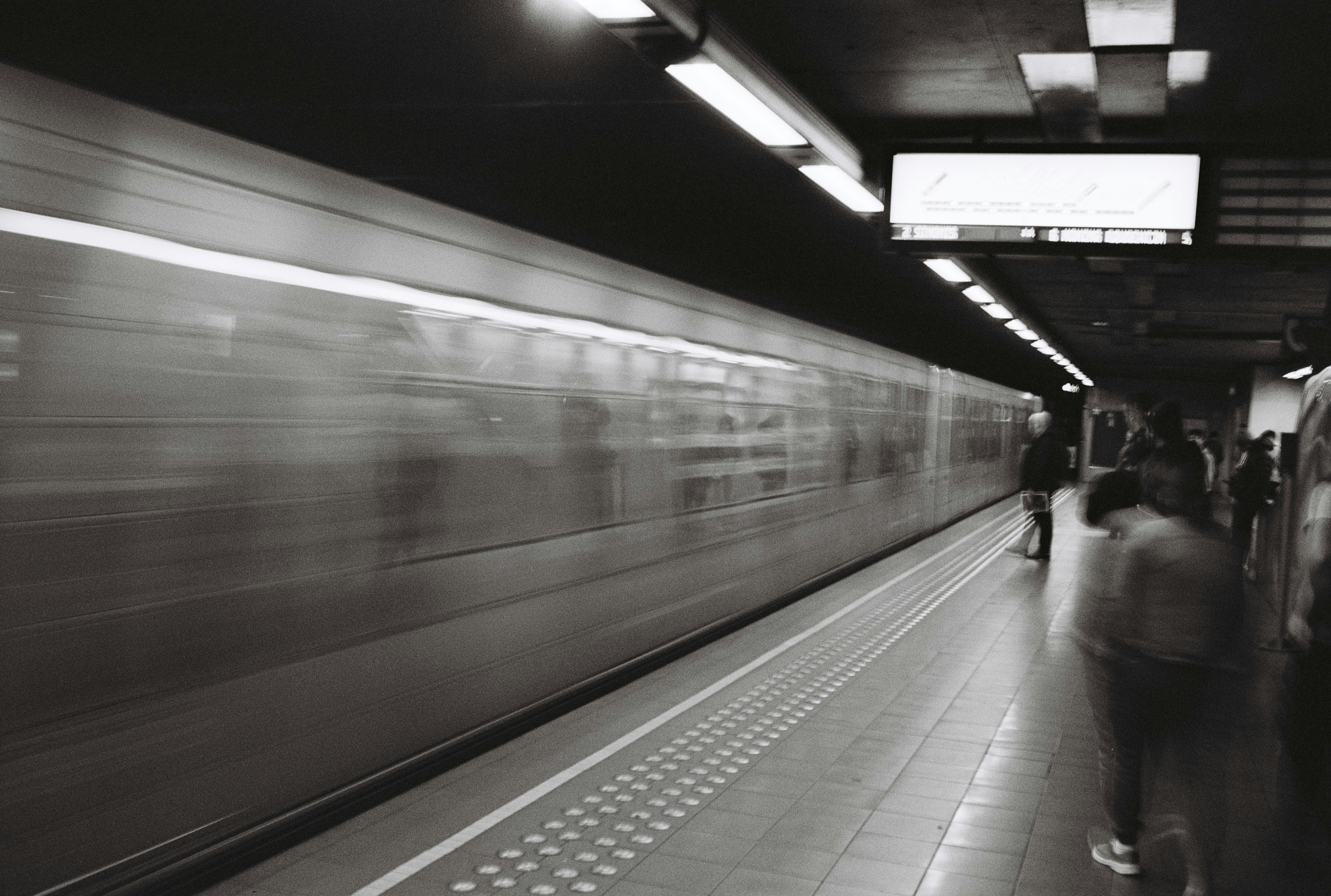 A black and white photo of people walking on the subway · Free Stock Photo