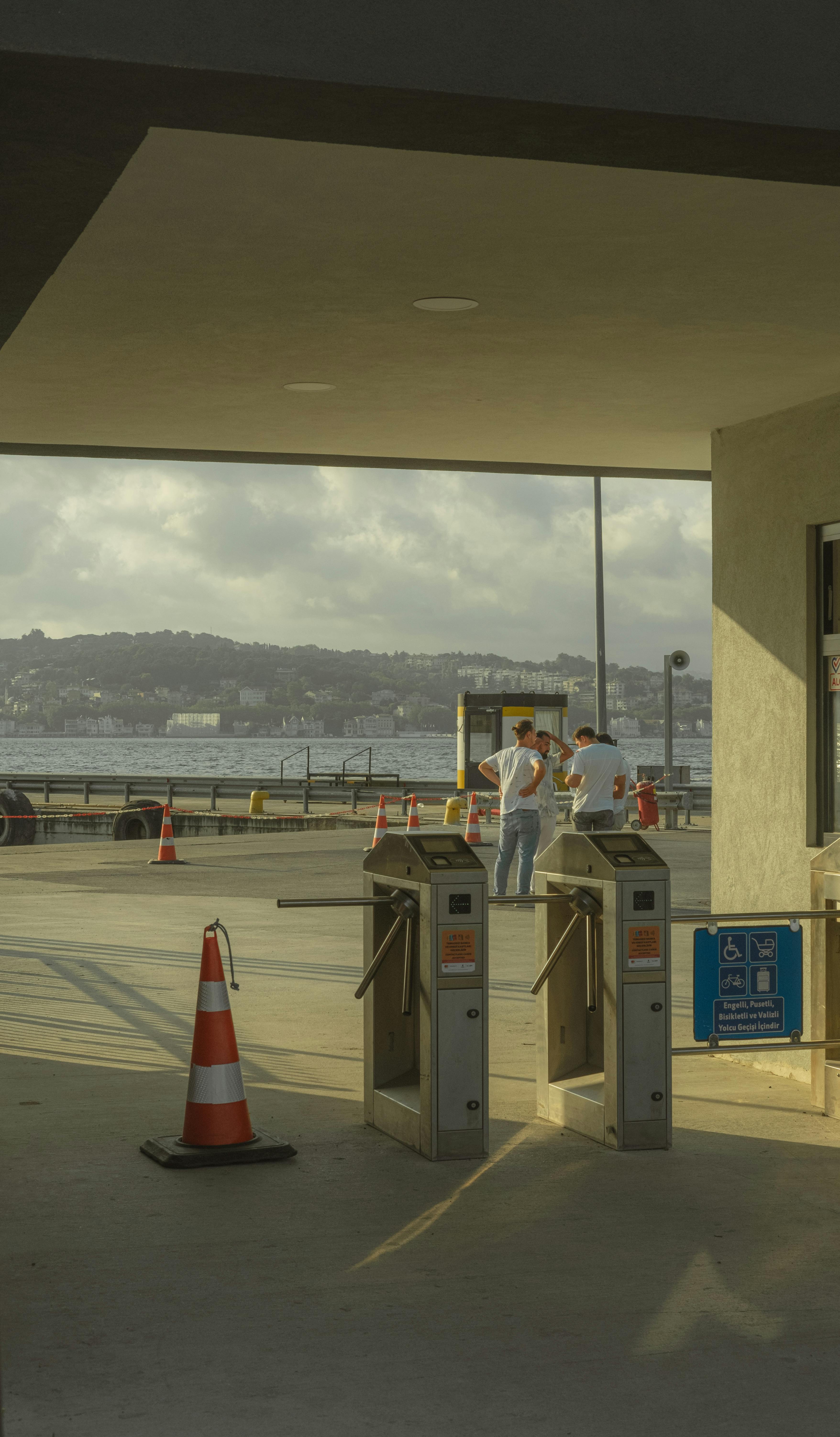 Group of Men Behind the Turnstile Gates of the Ferry Terminal · Free ...
