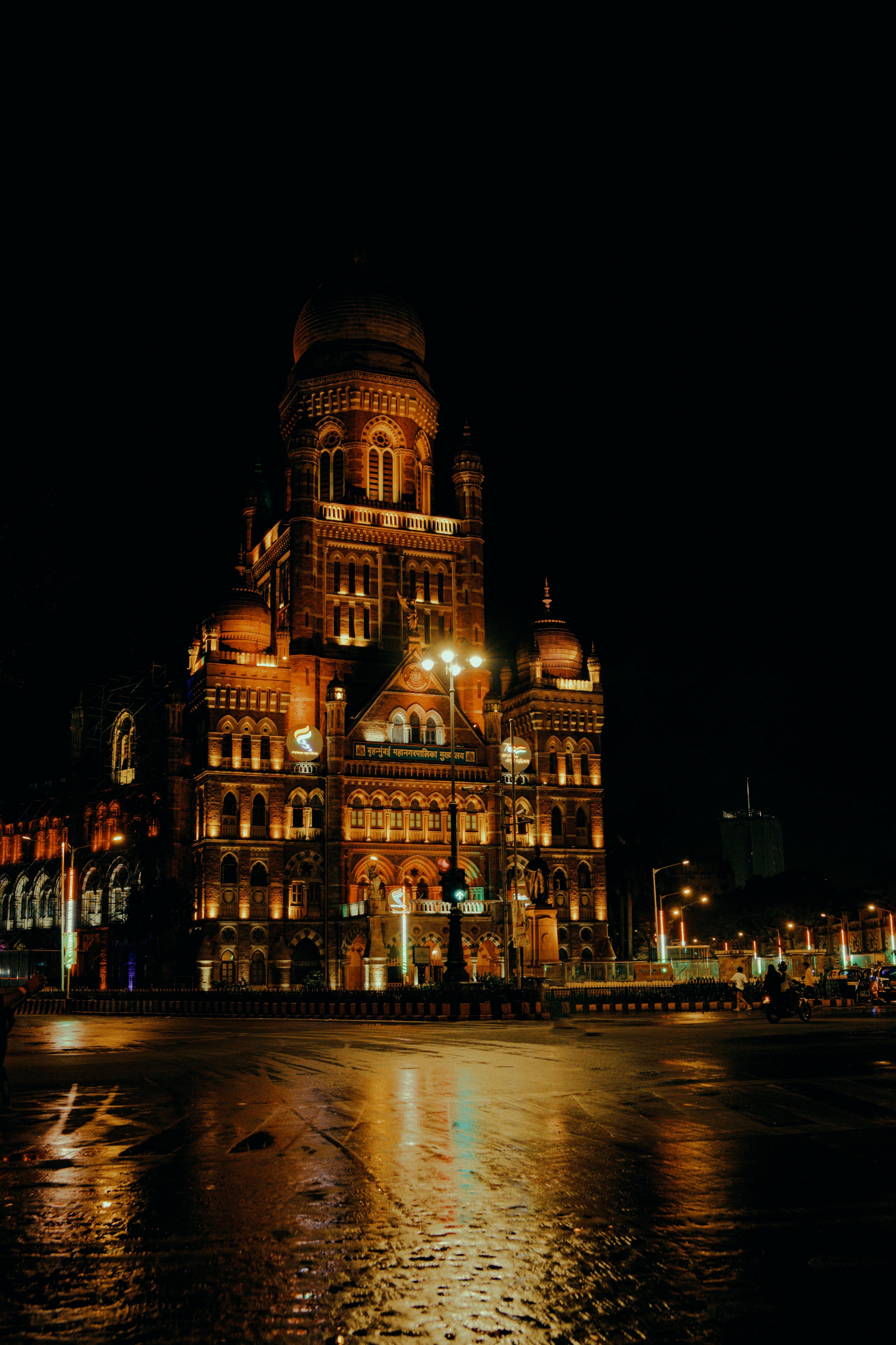 Gothic styled aged building in illuminated city at night · Free Stock Photo
