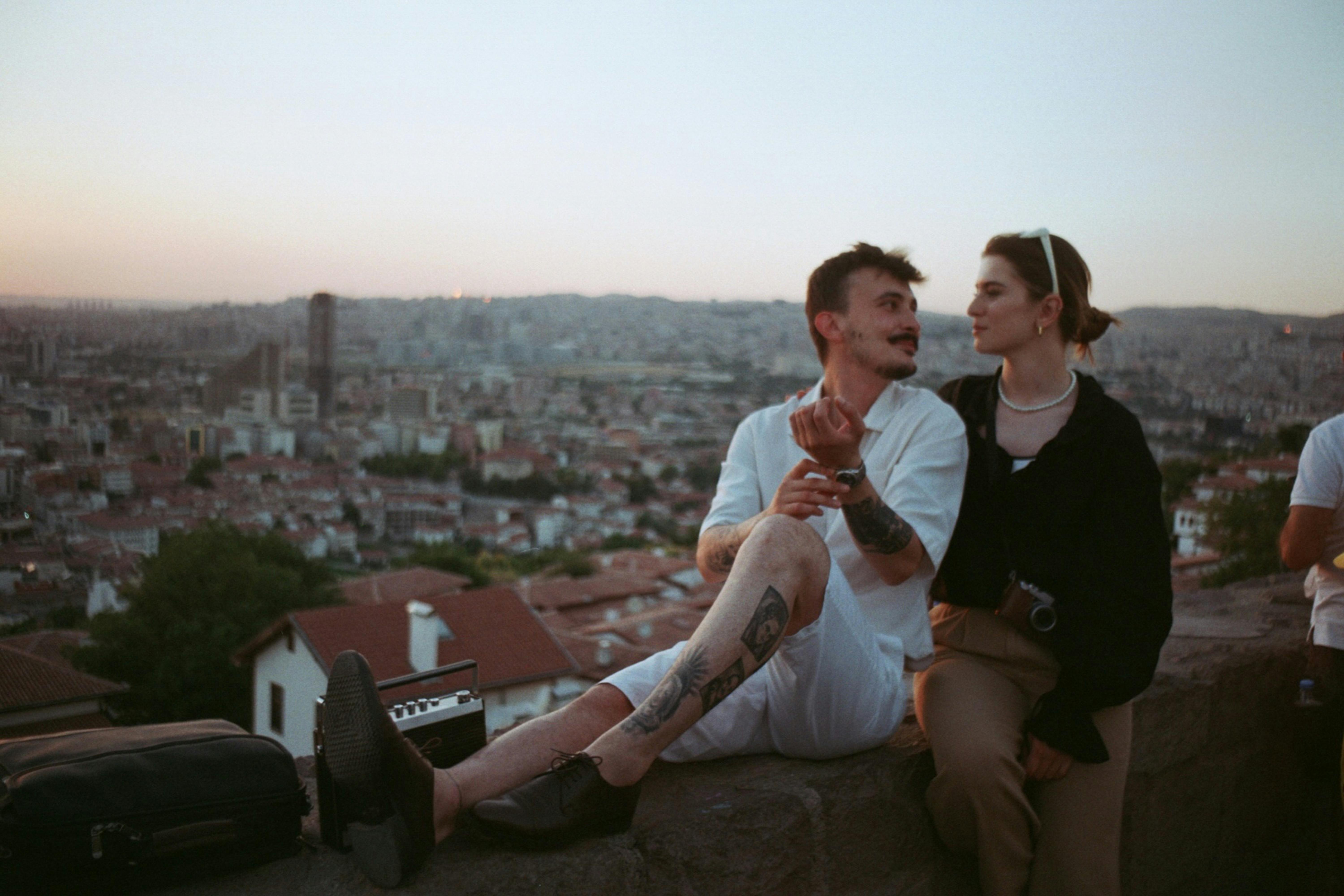 Couple Sitting on a Roof · Free Stock Photo