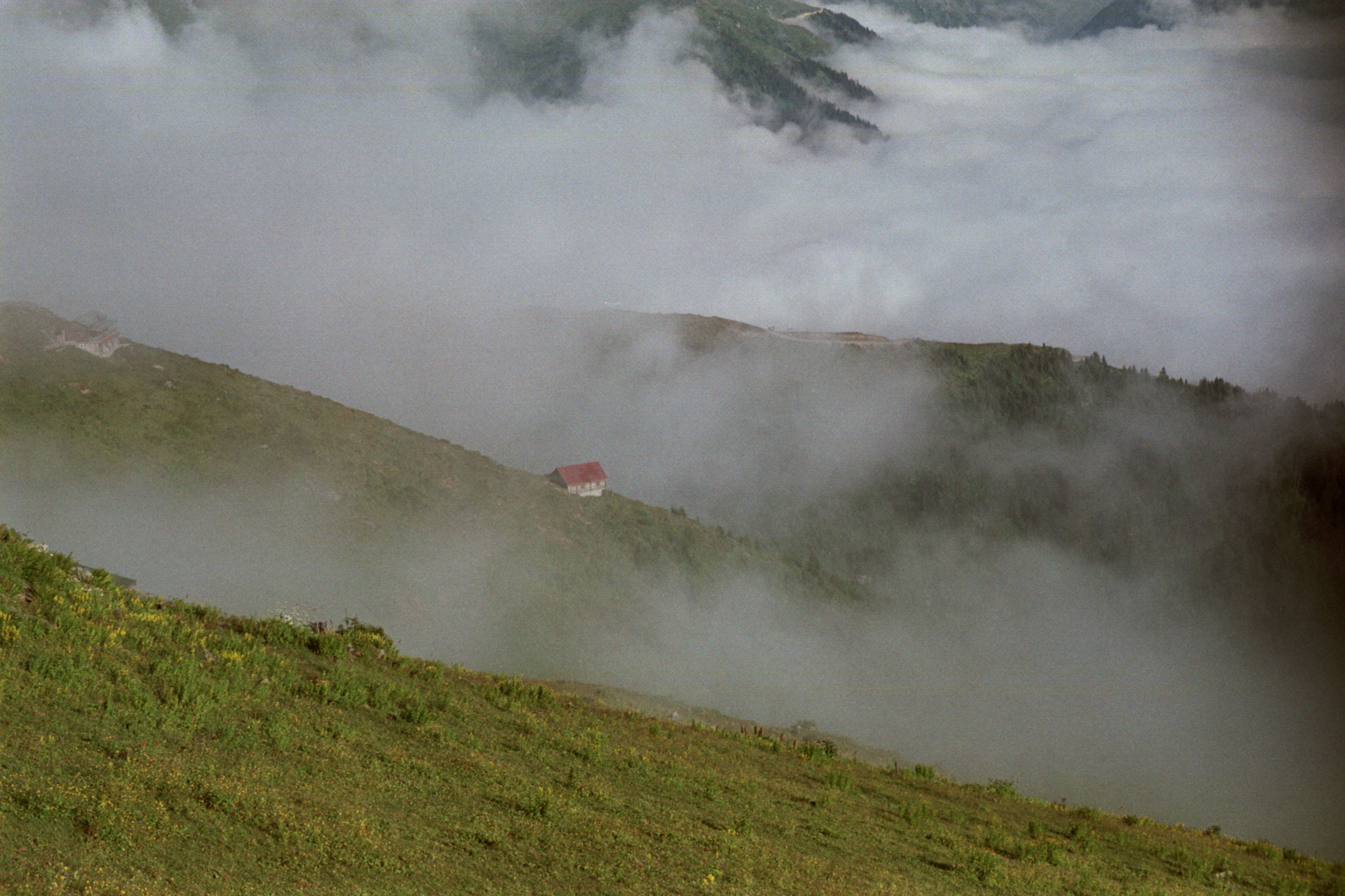 House in a Valley Covered with Fog · Free Stock Photo