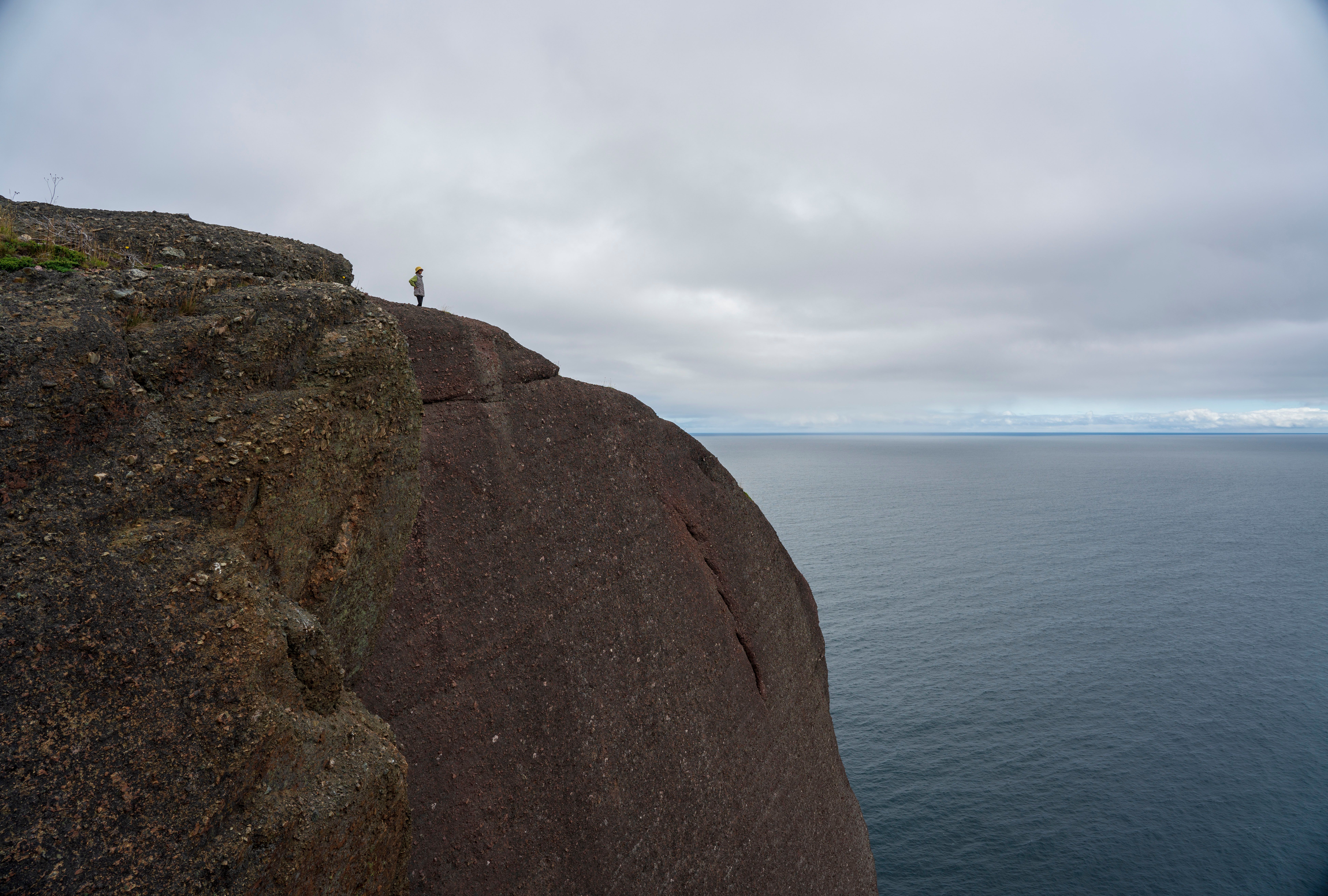 Silhouette of a Person Standing on the Top of a High Cliff · Free Stock ...