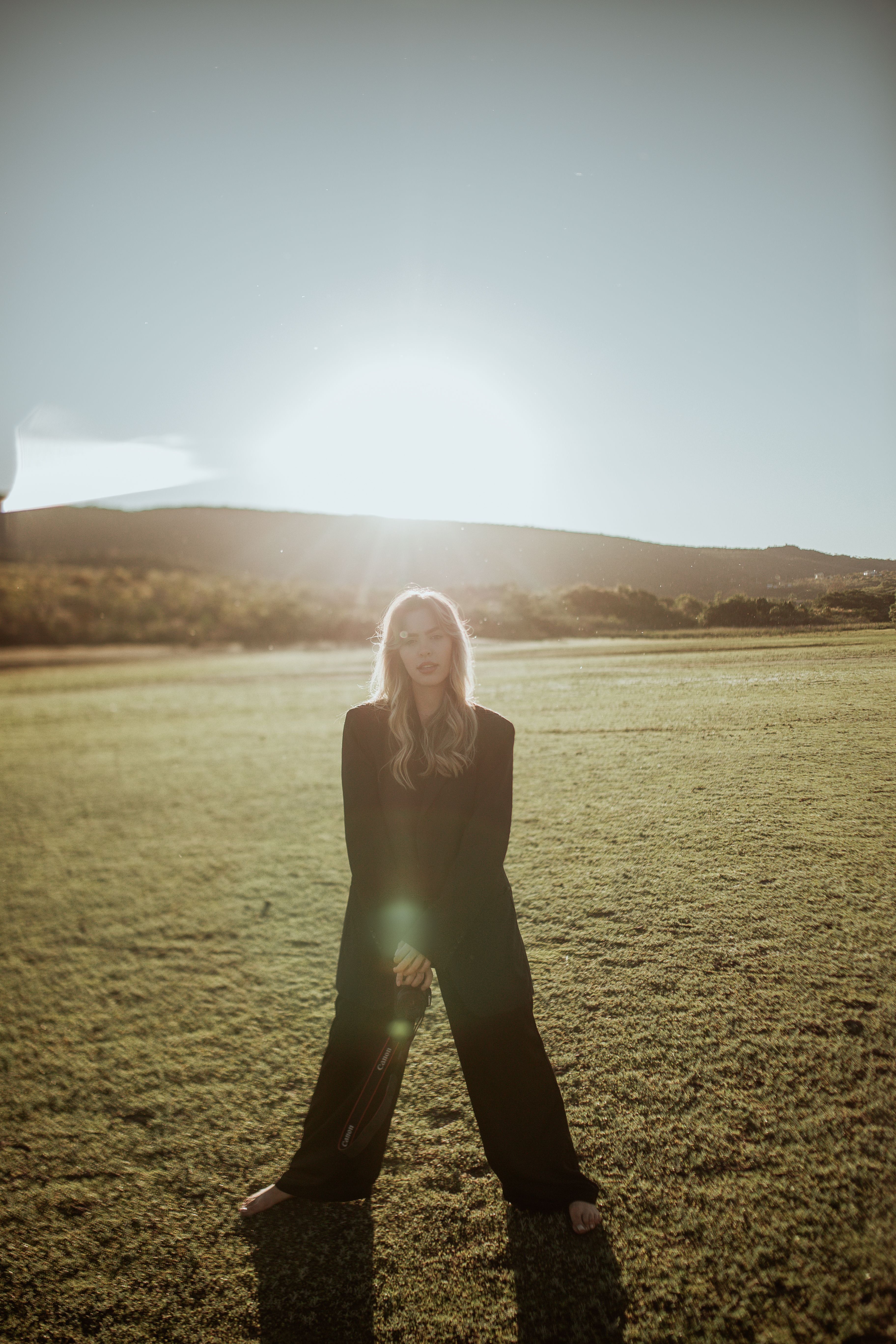 Blonde Woman Sitting over Hills and Valley · Free Stock Photo