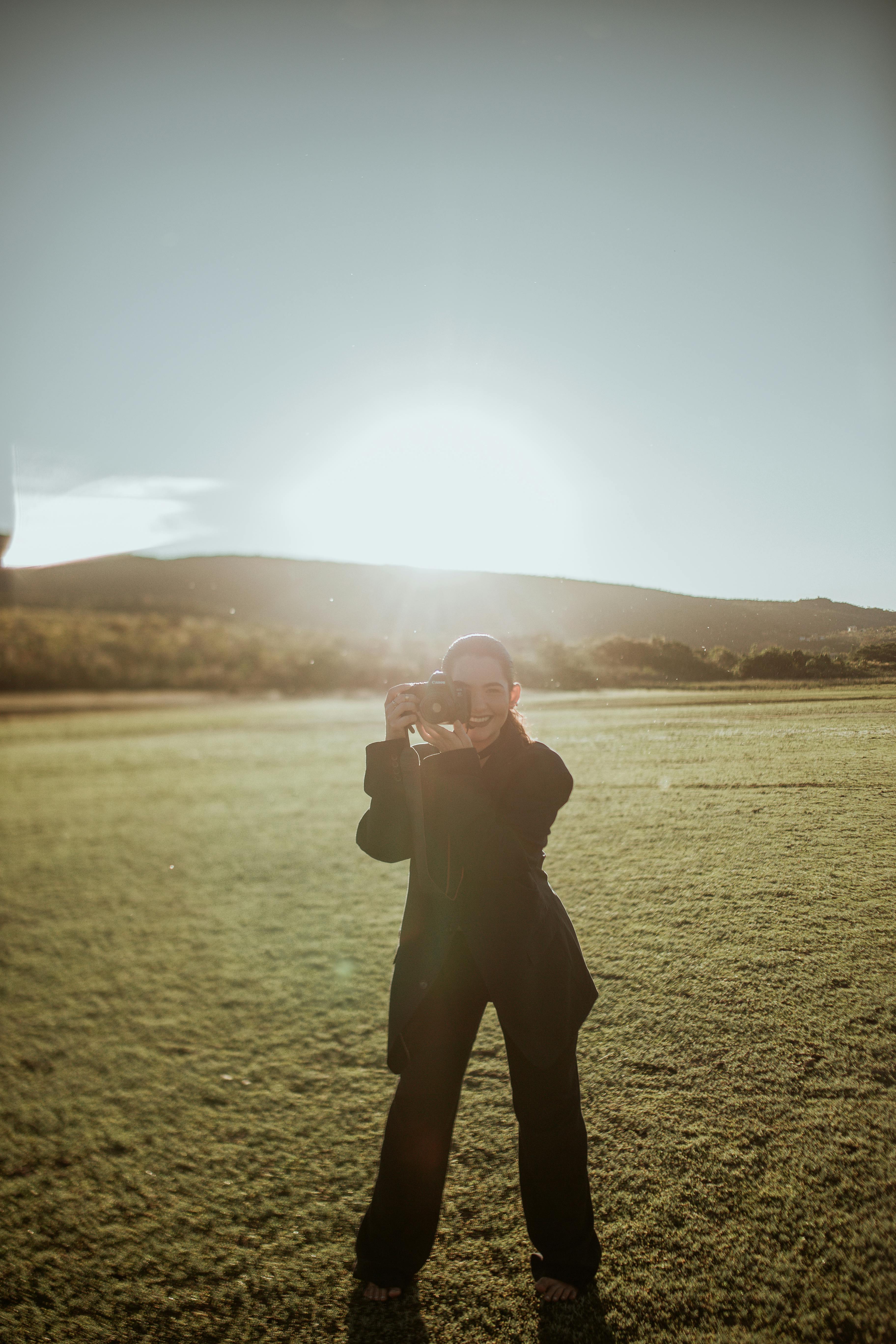 Sunlight over Woman Taking Pictures with Camera on Grassland · Free ...