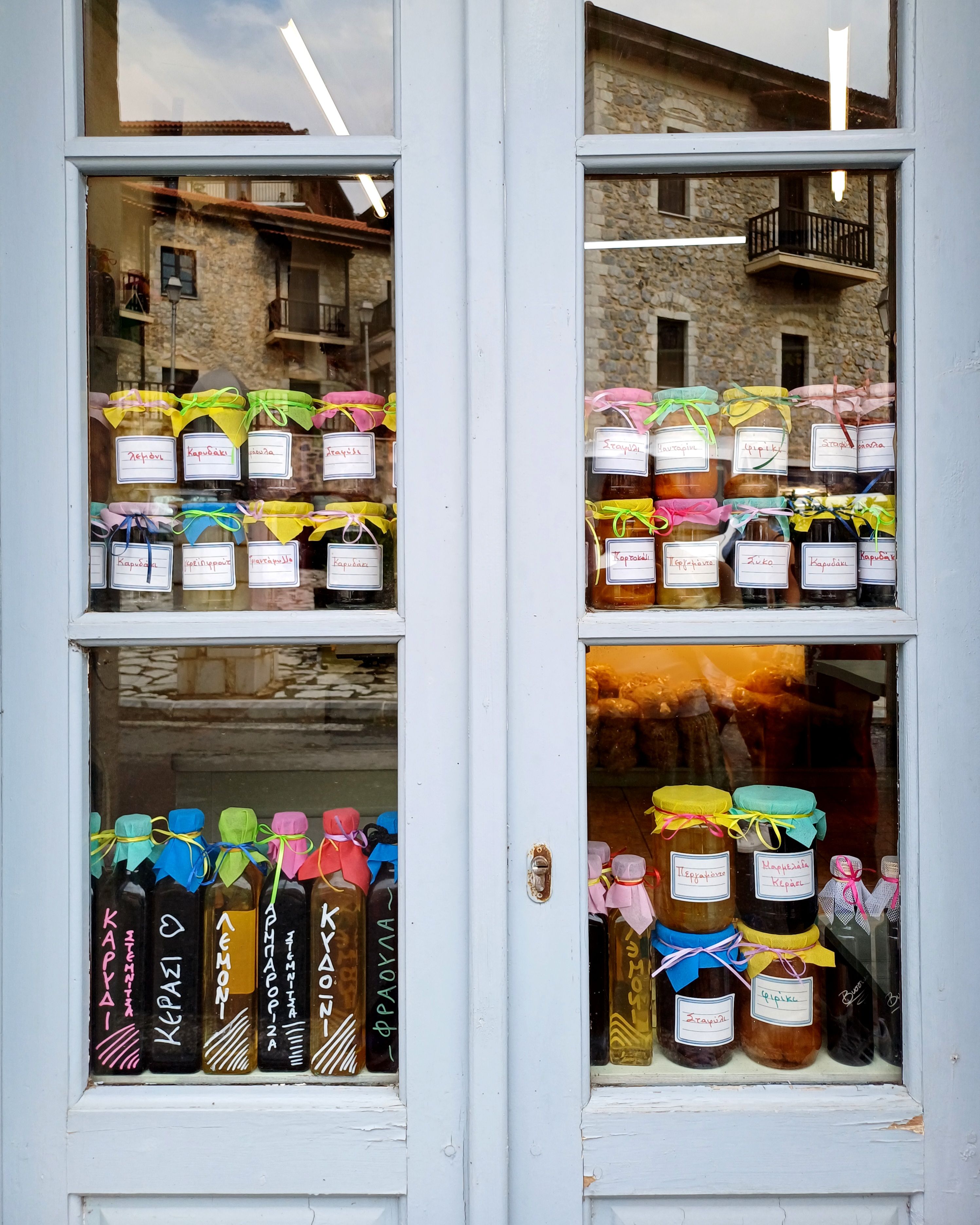 Glass Bottles and Jars on Display in the Shop Window · Free Stock Photo