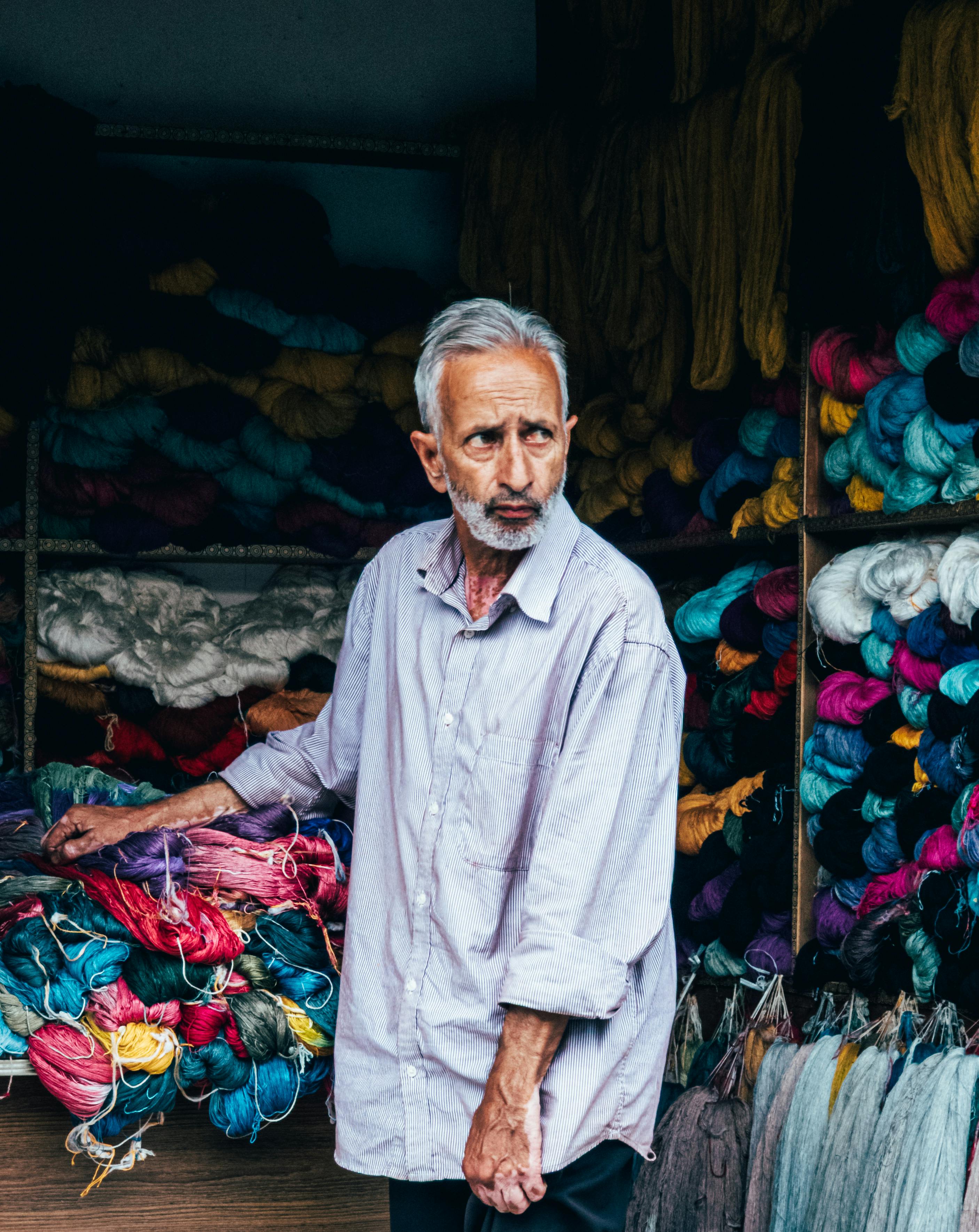 Man Standing in a Cluttered Antiques Shop · Free Stock Photo