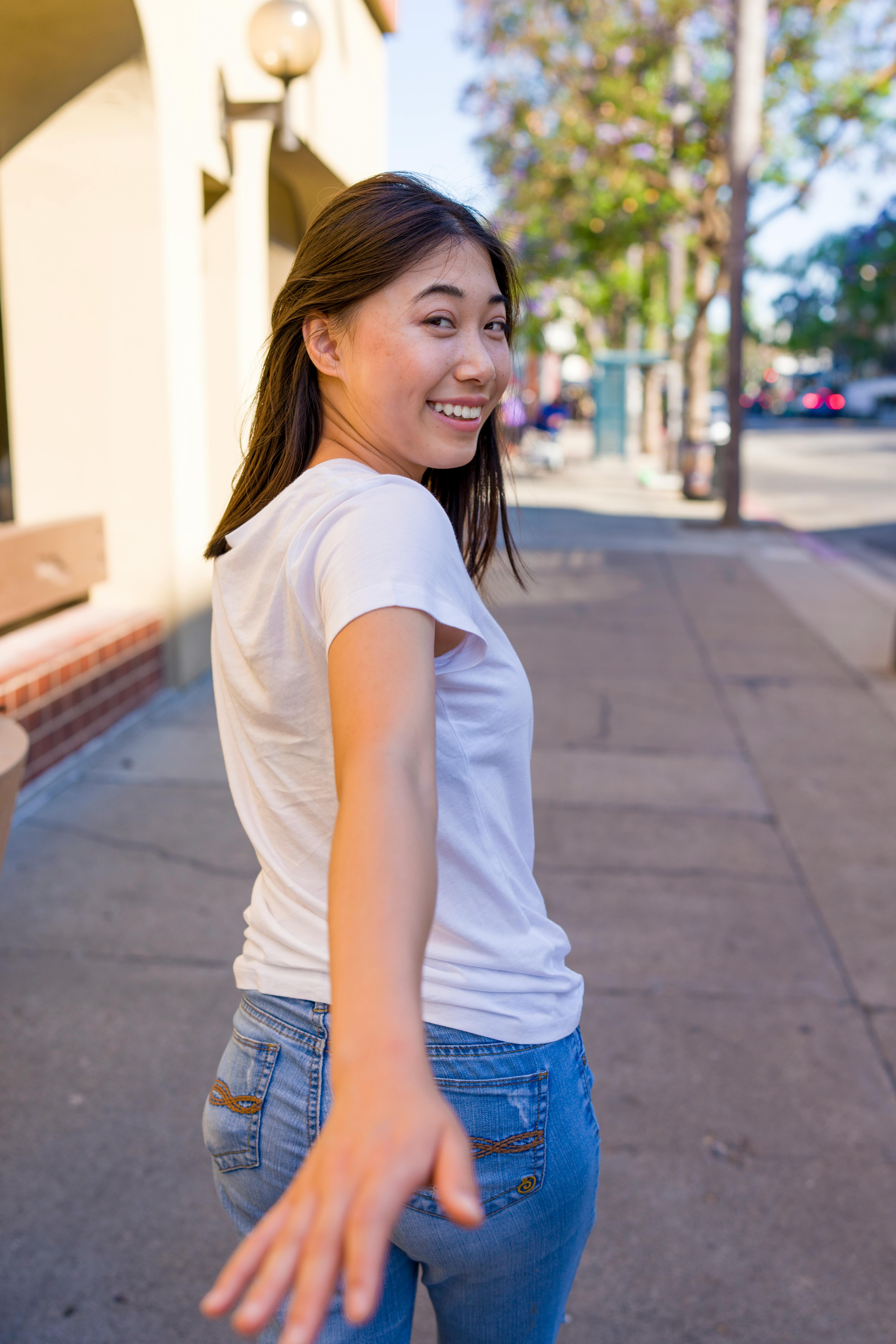 Young Asian Woman Looking Backwards and Reaching Out to Hold Hand ...